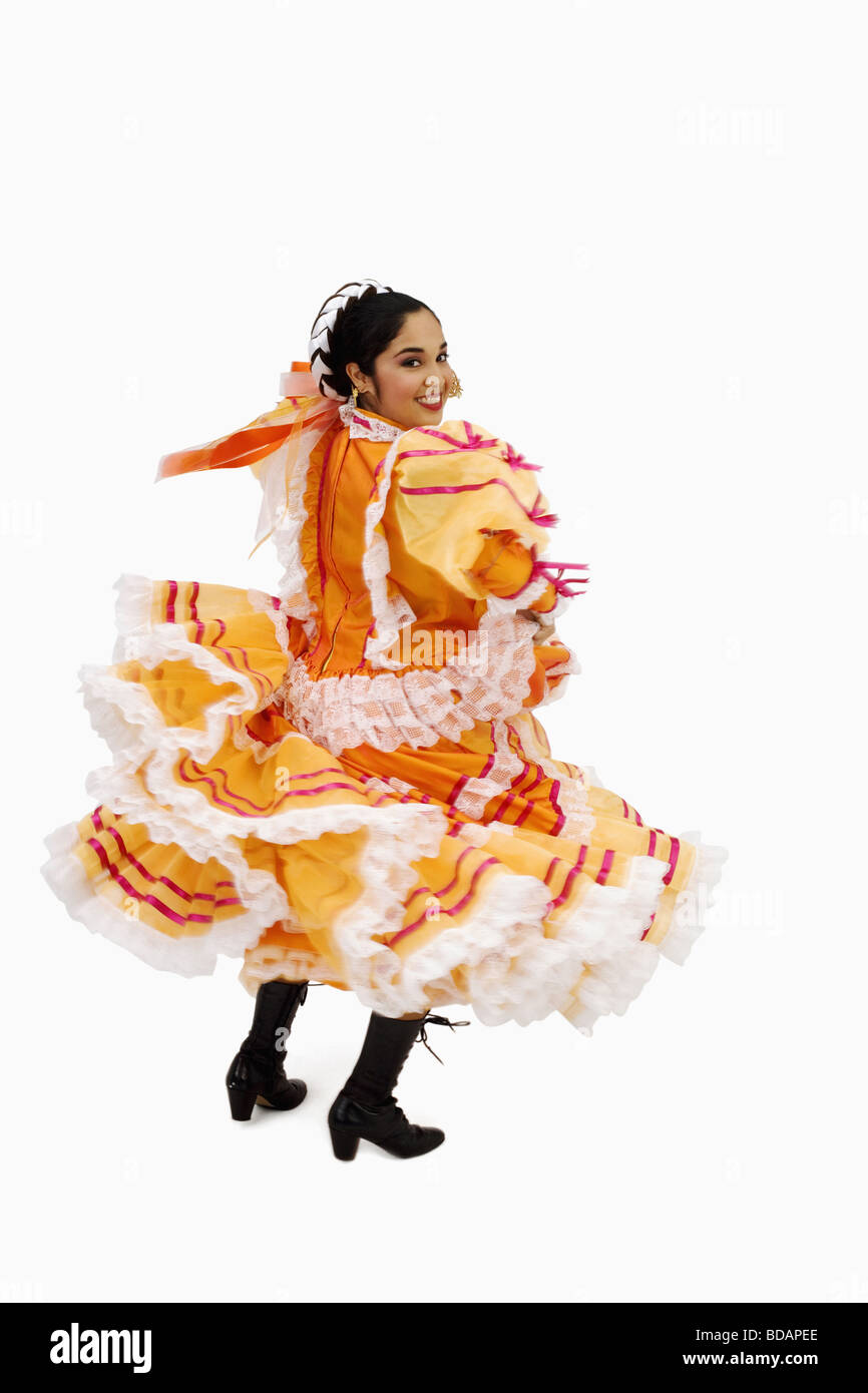 Young woman wearing traditional clothing and dancing Stock Photo - Alamy