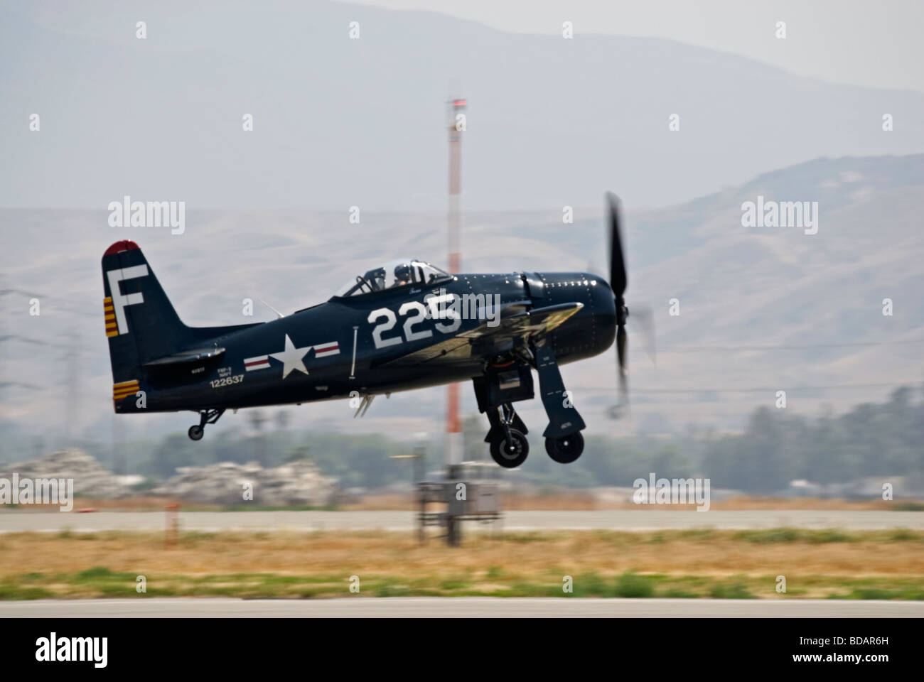 A Grumman F8F Bearcat takes off at an air show Stock Photo - Alamy