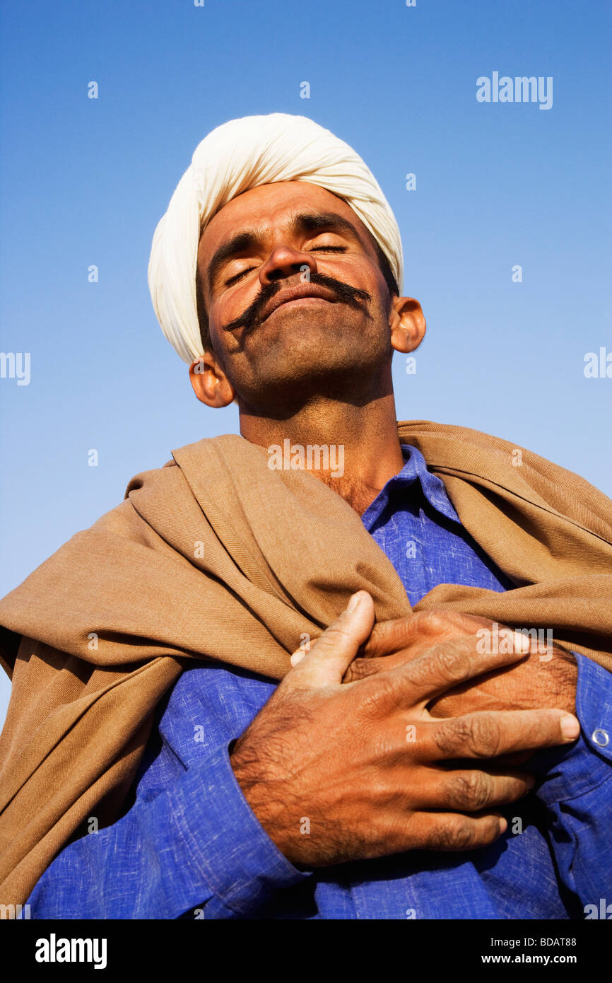 Low angle view of a man with his eyes closed, Jaisalmer, Rajasthan ...