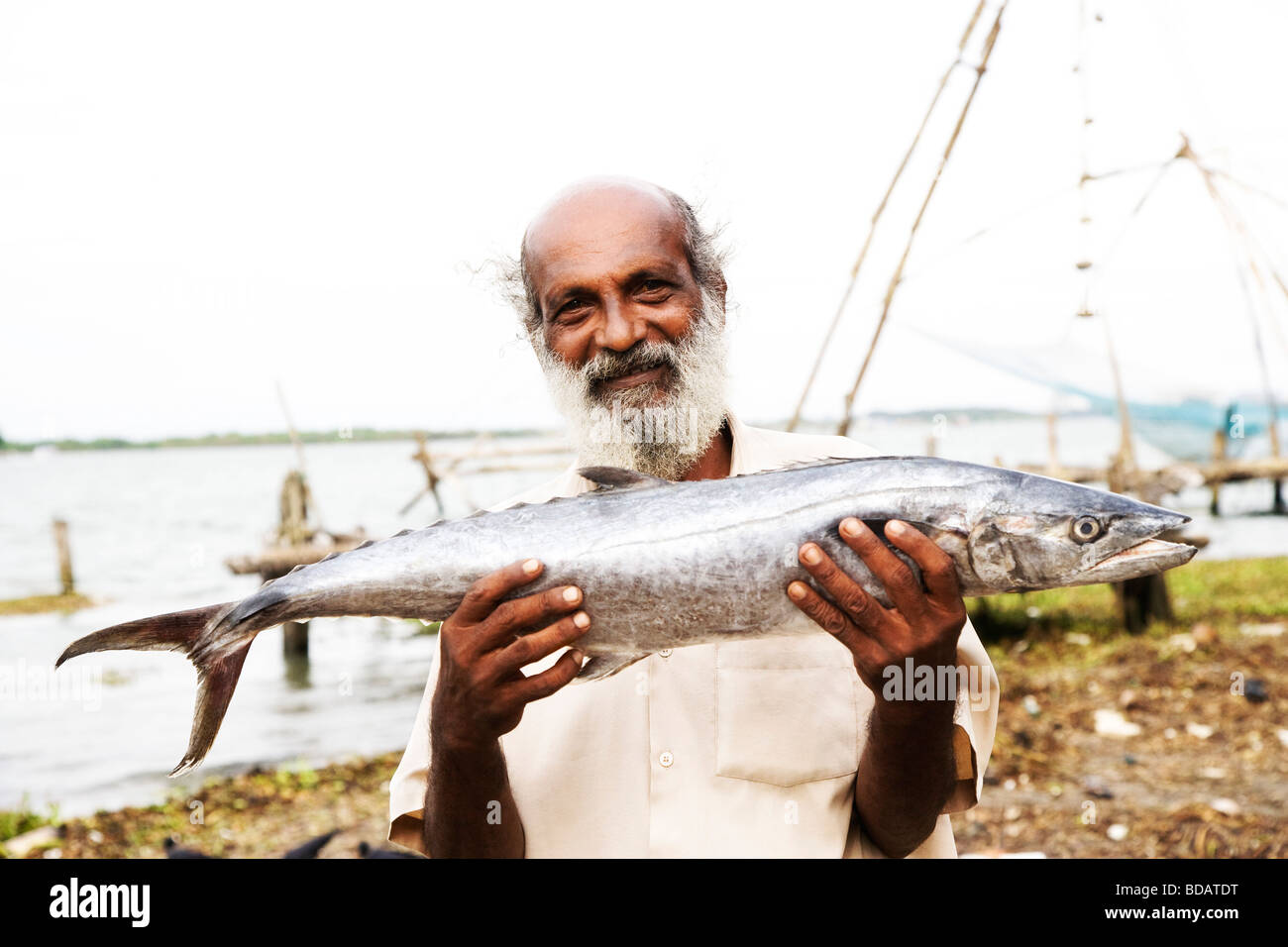 Fisherman holding a fish, Cochin, Kerala, India Stock Photo - Alamy