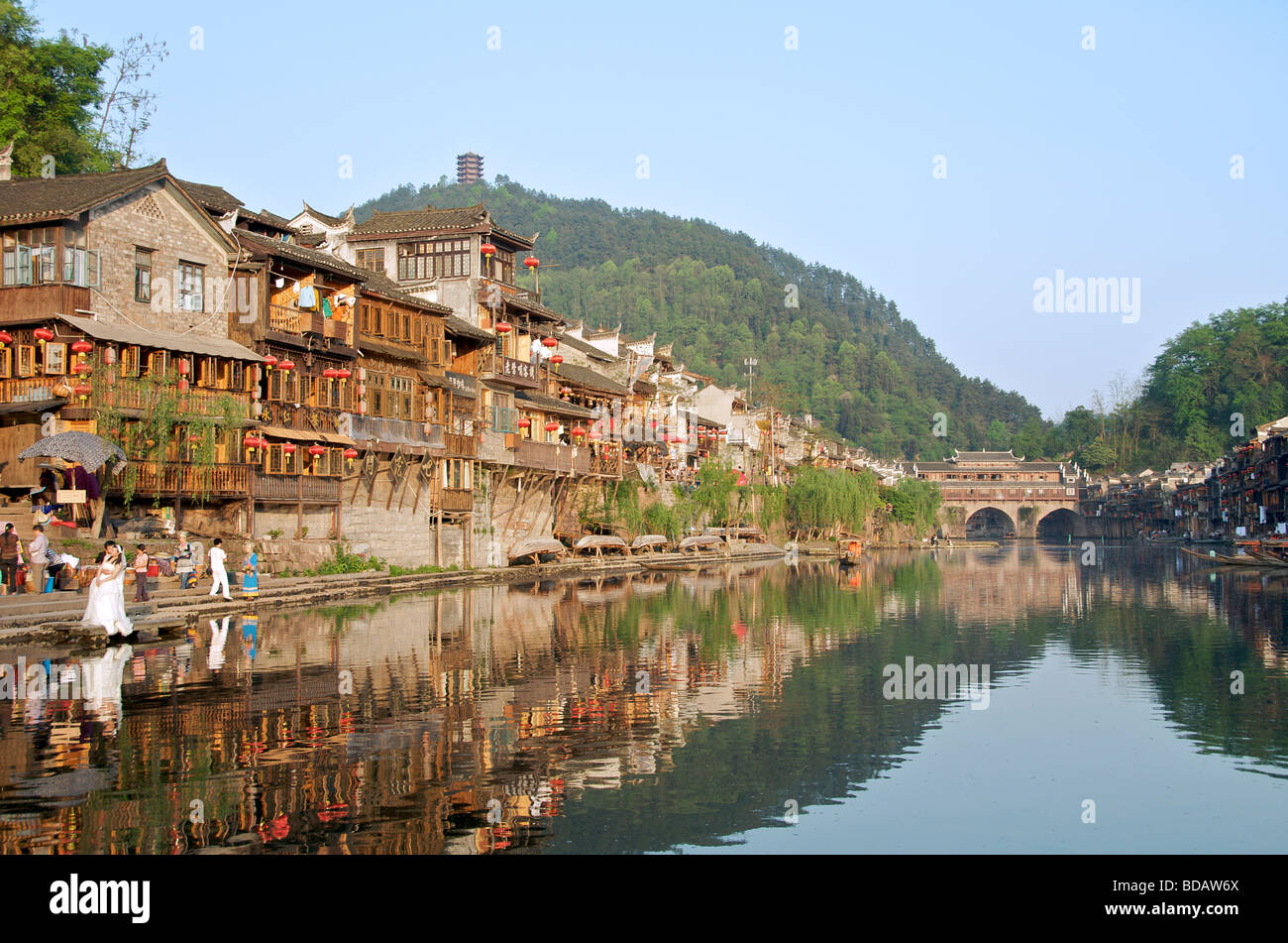 Riverfront wooden buildings on Tuo River in evening light Ancient Town ...