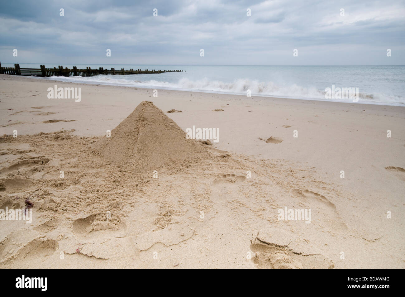 Sandcastle pyramid at the seaside Stock Photo - Alamy