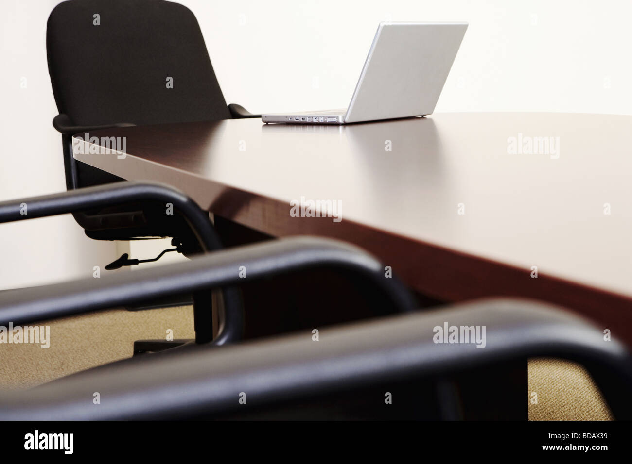 Laptop on a conference table Stock Photo - Alamy