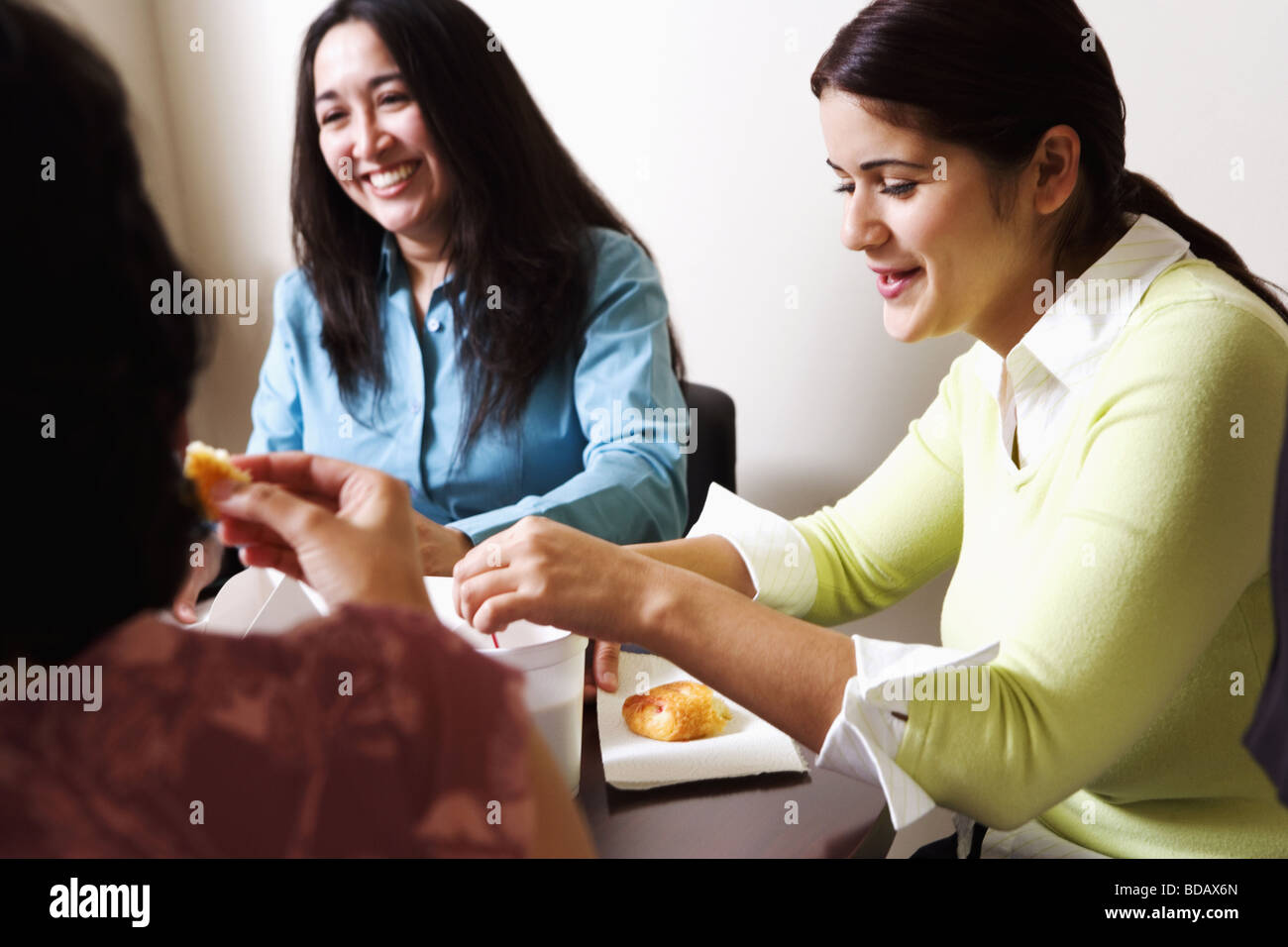 Businesswomen eating food in an office Stock Photo - Alamy