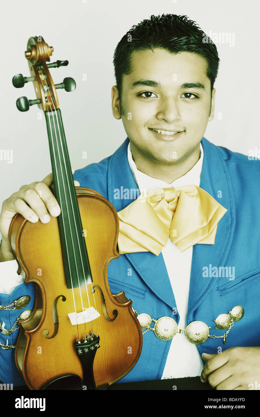 Portrait of a young man holding a violin and smiling Stock Photo - Alamy