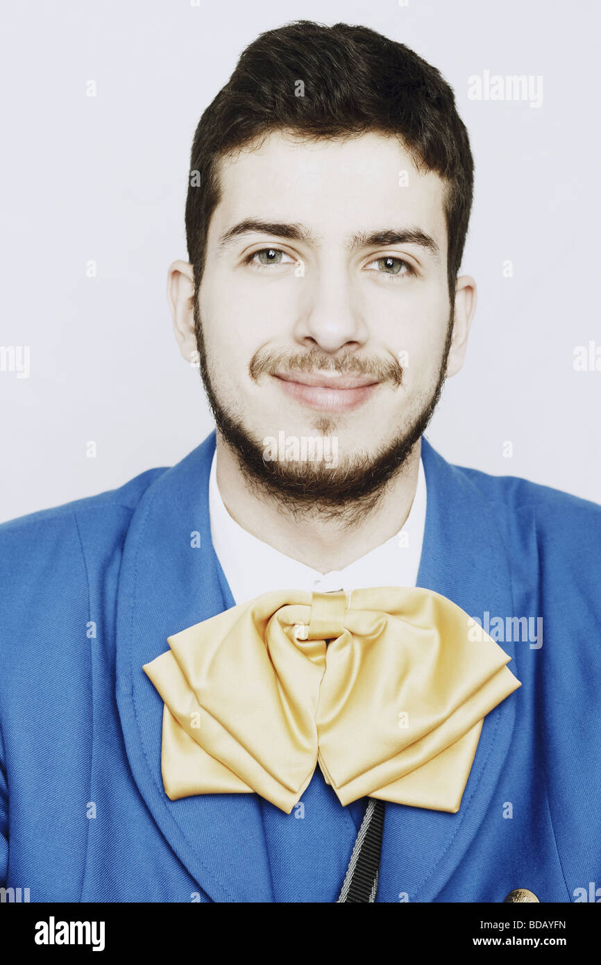 Portrait of a young man grinning in traditional clothing Stock Photo ...