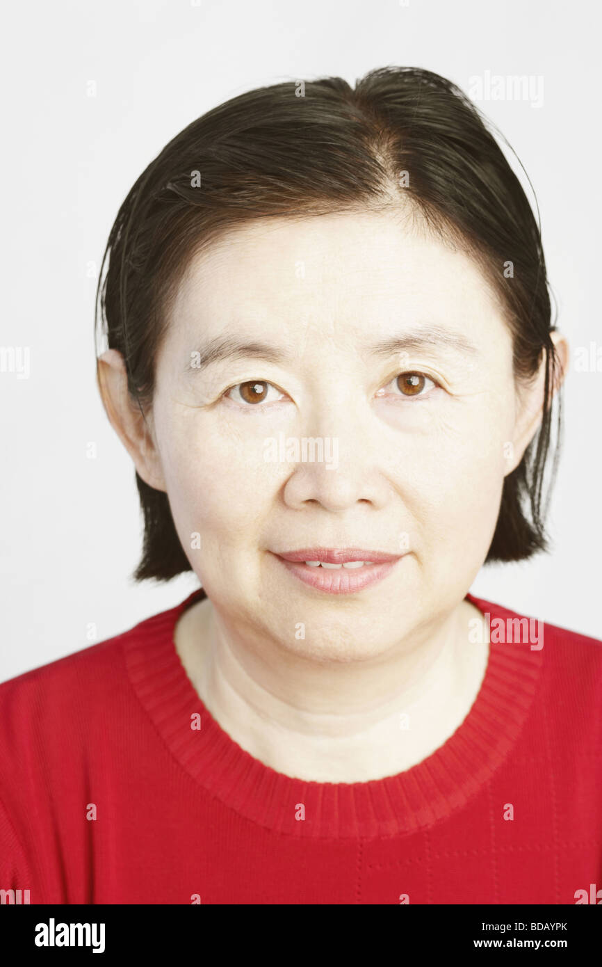 Portrait of a woman smirking hi-res stock photography and images - Alamy