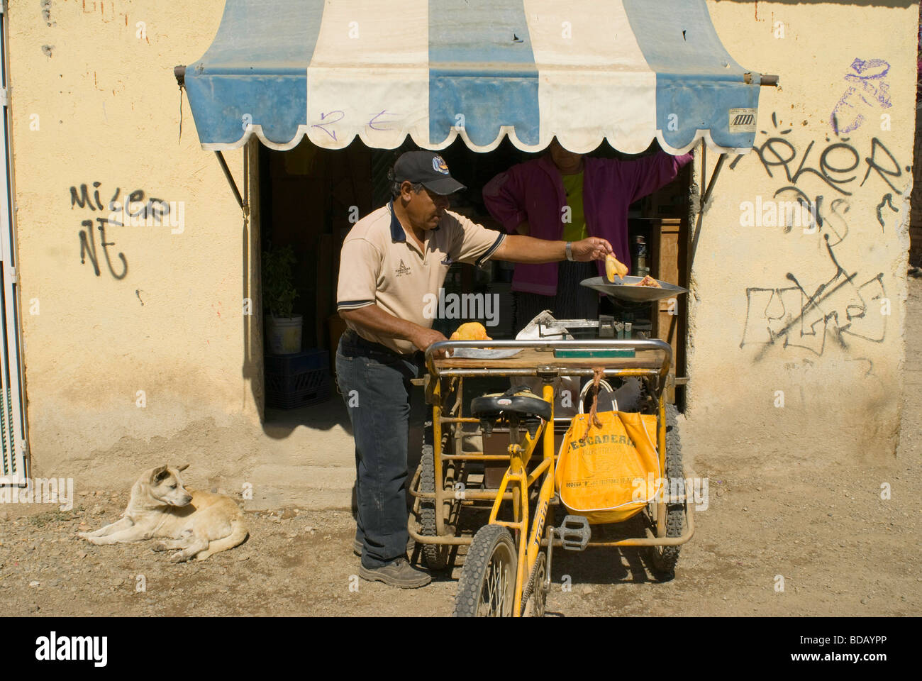 A door to door salesman sells chicken to a client on the main street of ...