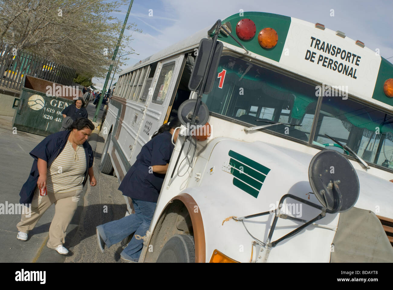 Workers from the Salter Labs de México maquiladora board company buses ...