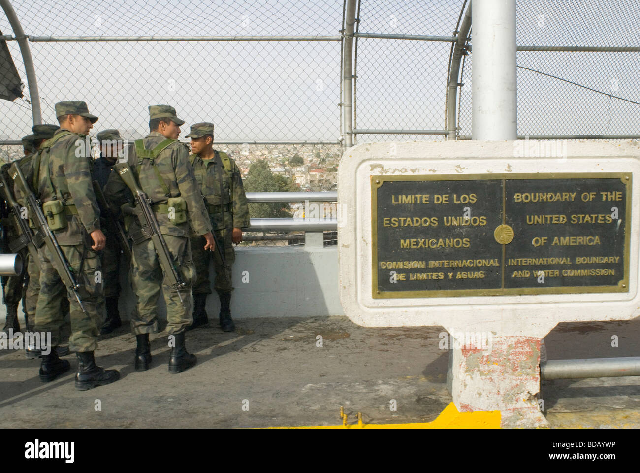 A small group of Mexican army soldiers walks along the Santa Fe Bridge ...