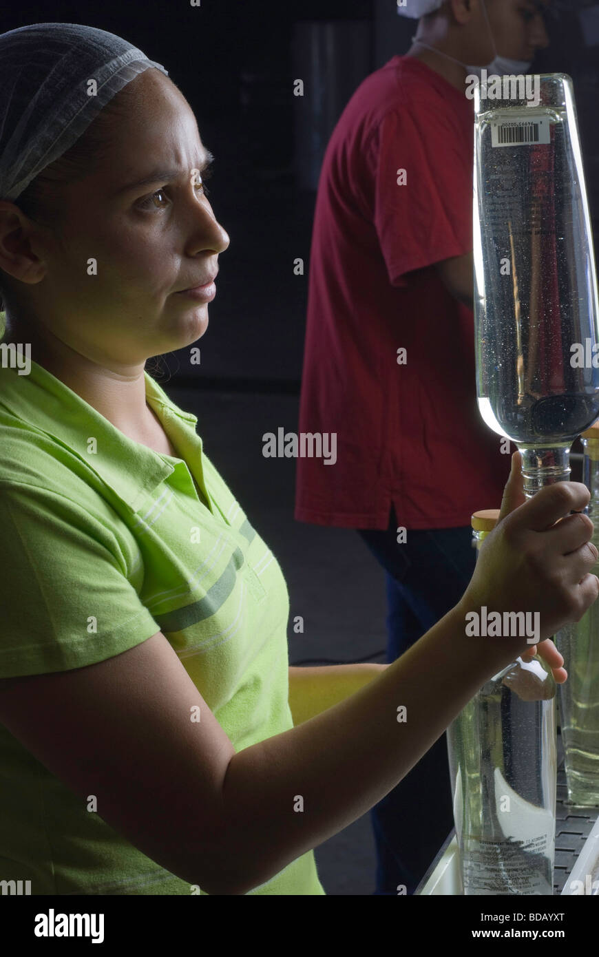 A quality control worker checks bottles of tequila at the facilities of ...
