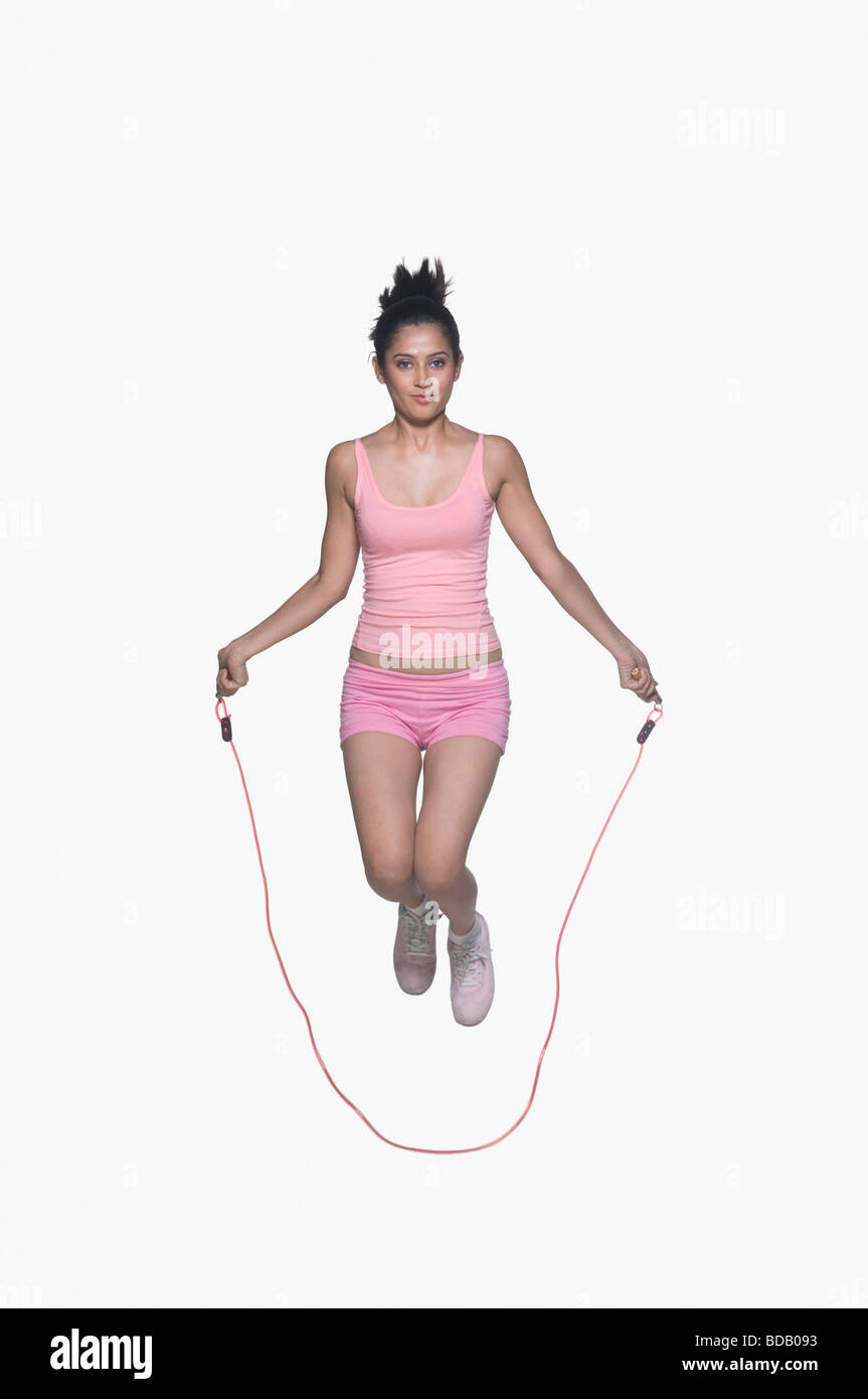 Portrait of a young woman jumping rope Stock Photo - Alamy