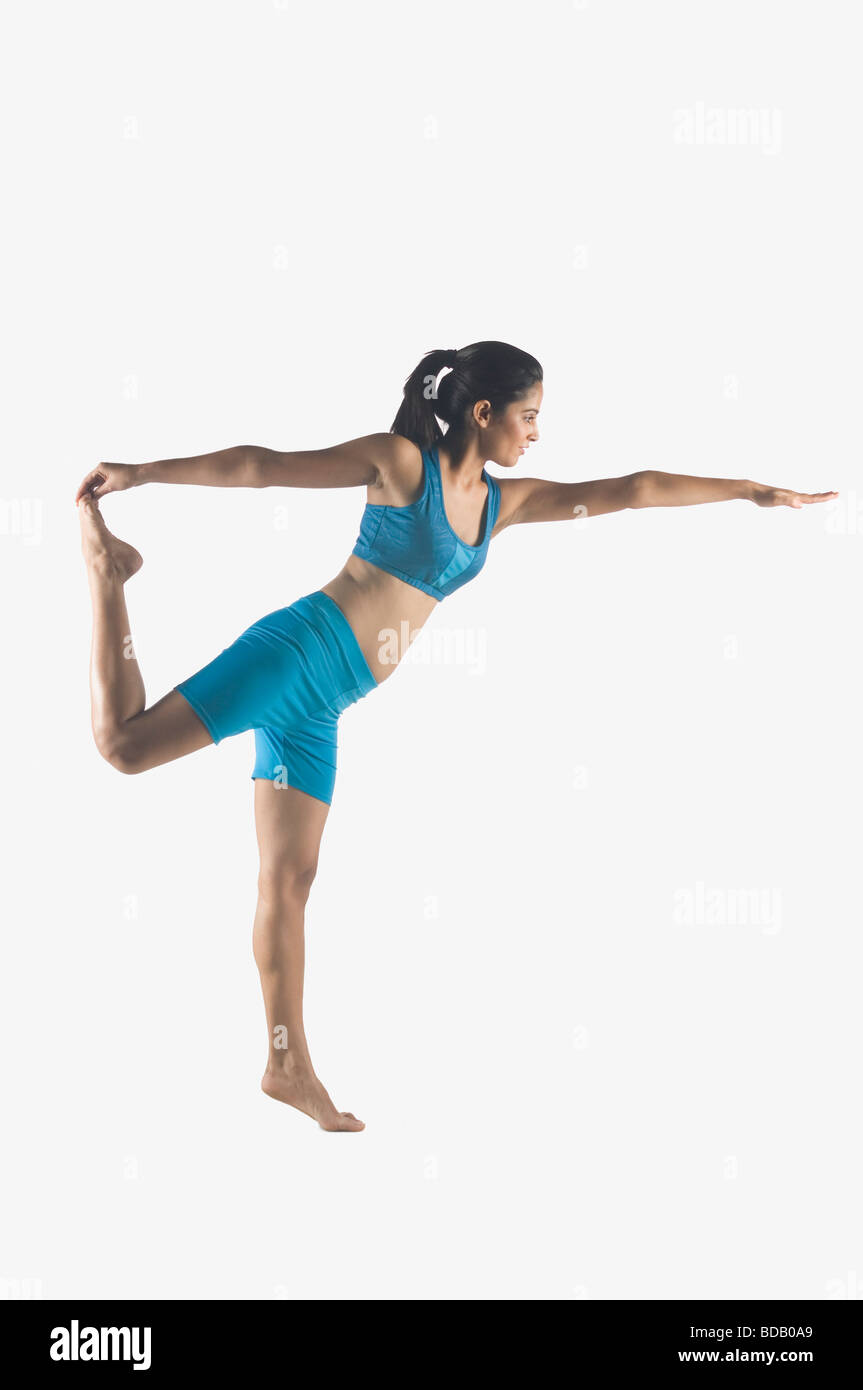 Side profile of a young woman stretching Stock Photo - Alamy