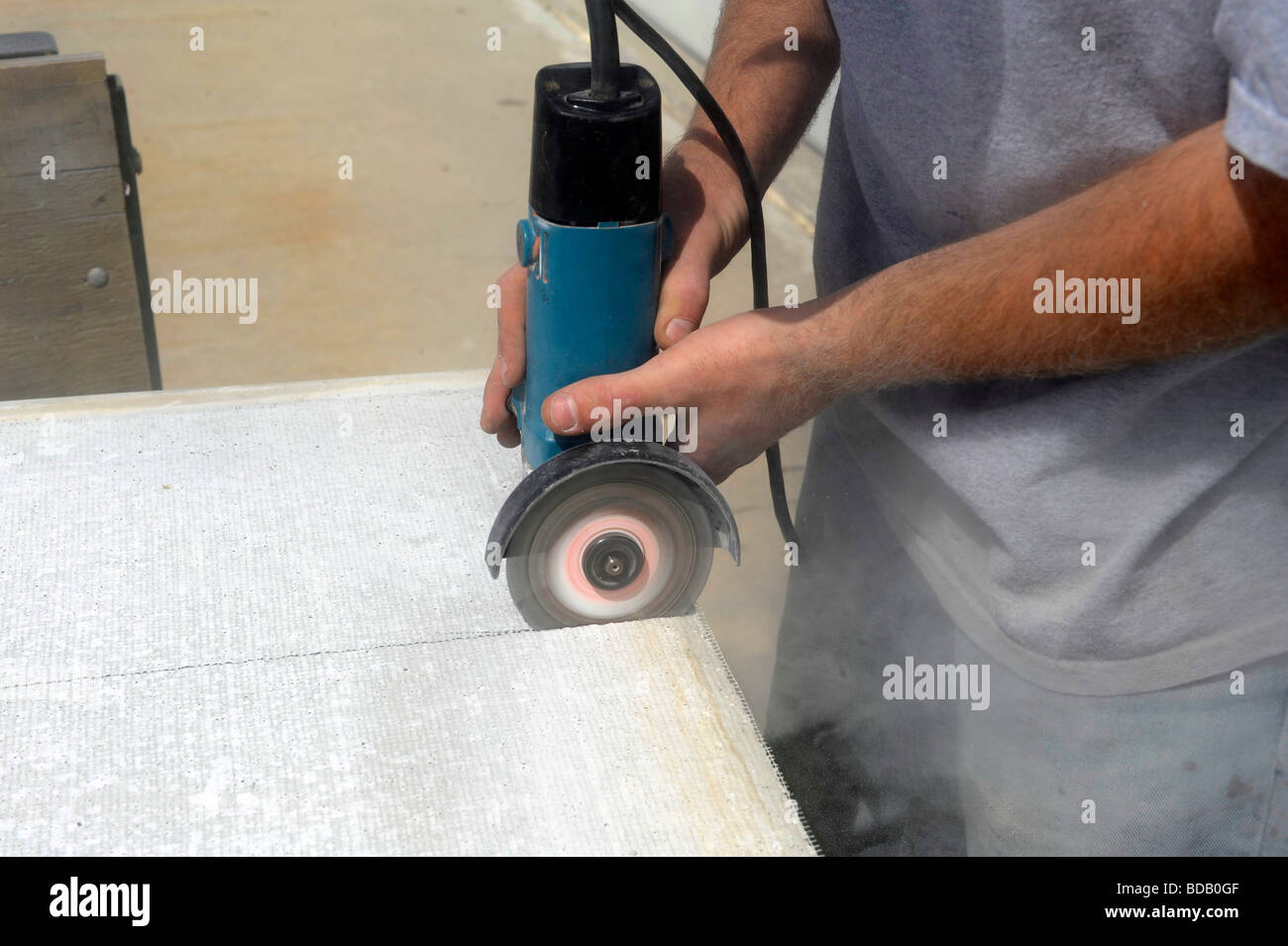 Carpenter using power cutting tool in construction project Stock Photo ...