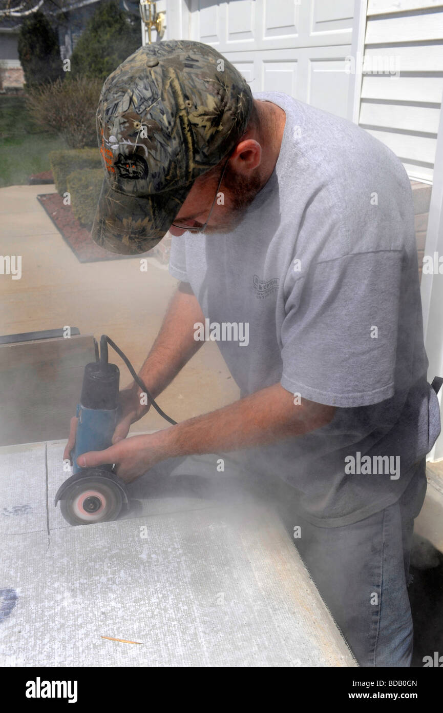 Carpenter using power cutting tool in construction project Stock Photo ...