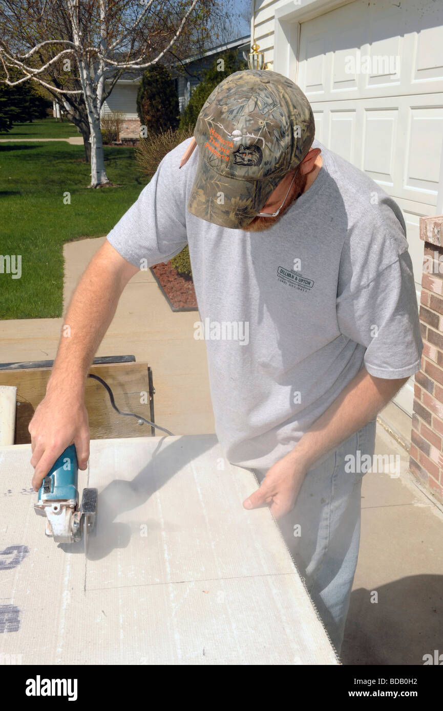 Carpenter using power cutting tool in construction project Stock Photo ...