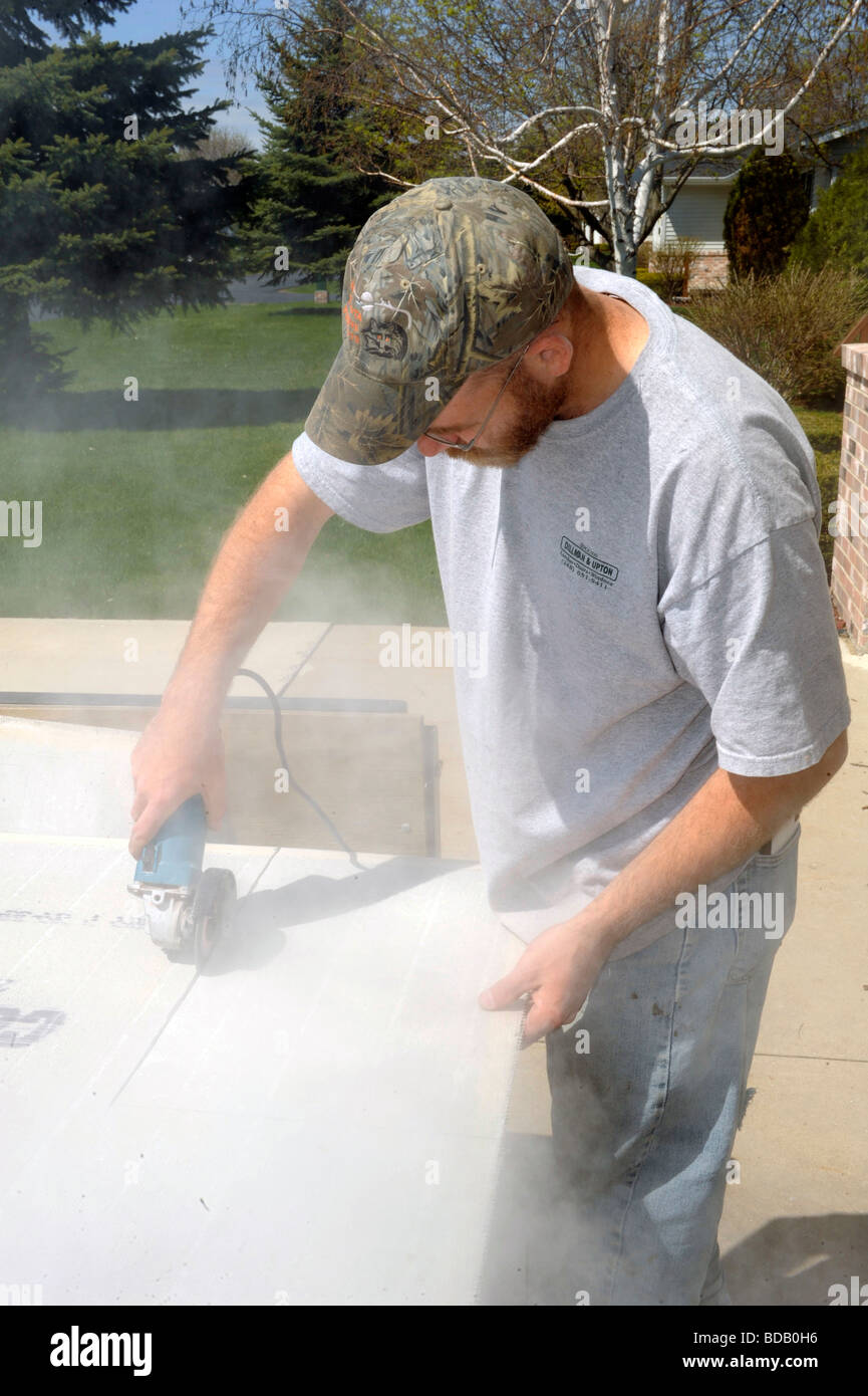 Carpenter using power cutting tool in construction project Stock Photo ...