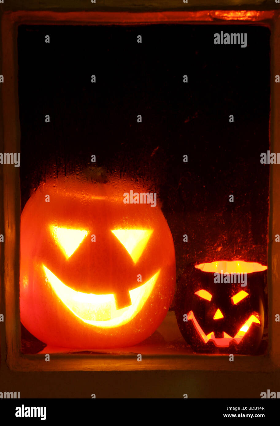 Two halloween pumpkins in a window Stock Photo - Alamy