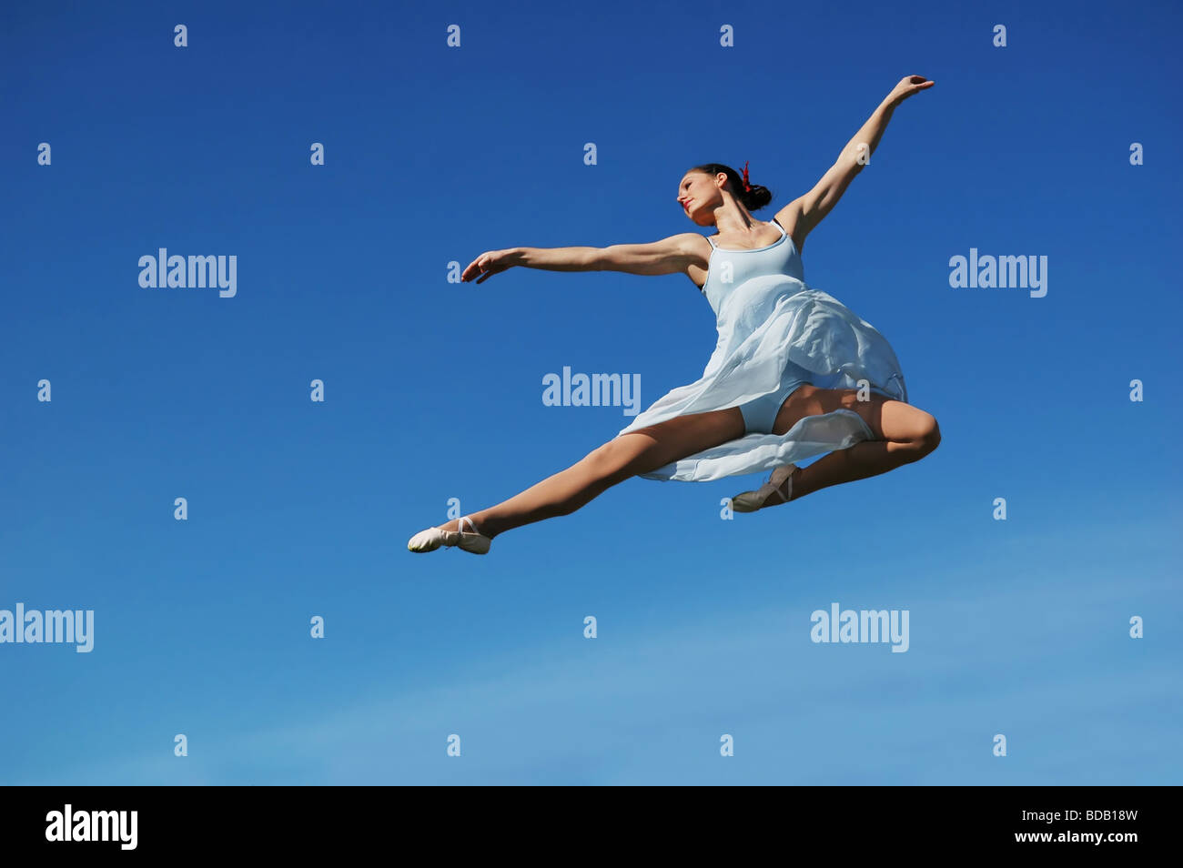 Ballerina performing a jump on a sunny day Stock Photo - Alamy
