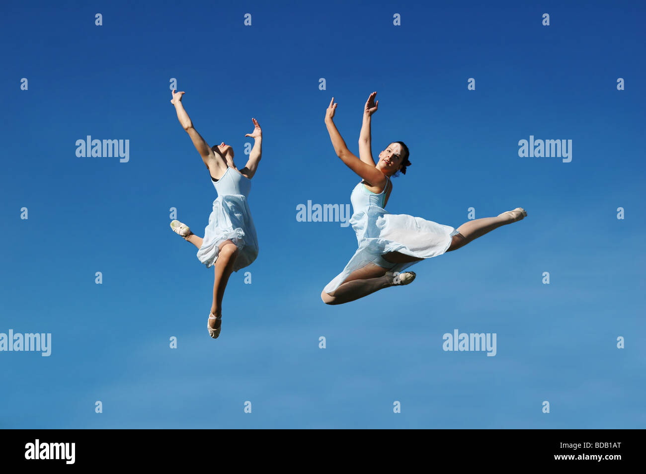 Ballerinas jumping against a blue sky Stock Photo - Alamy