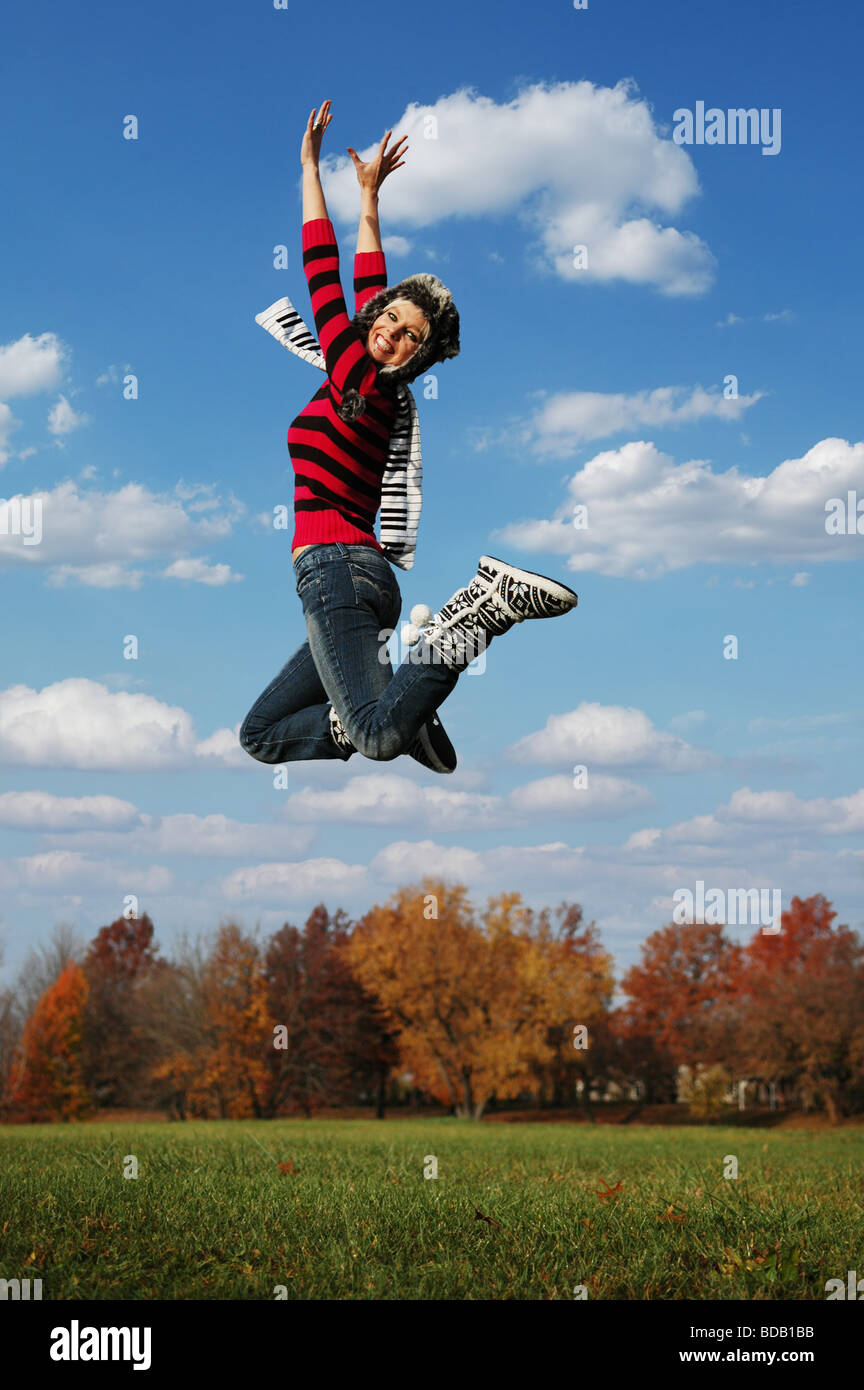 Jumping girl on a beautiful fall day Stock Photo - Alamy