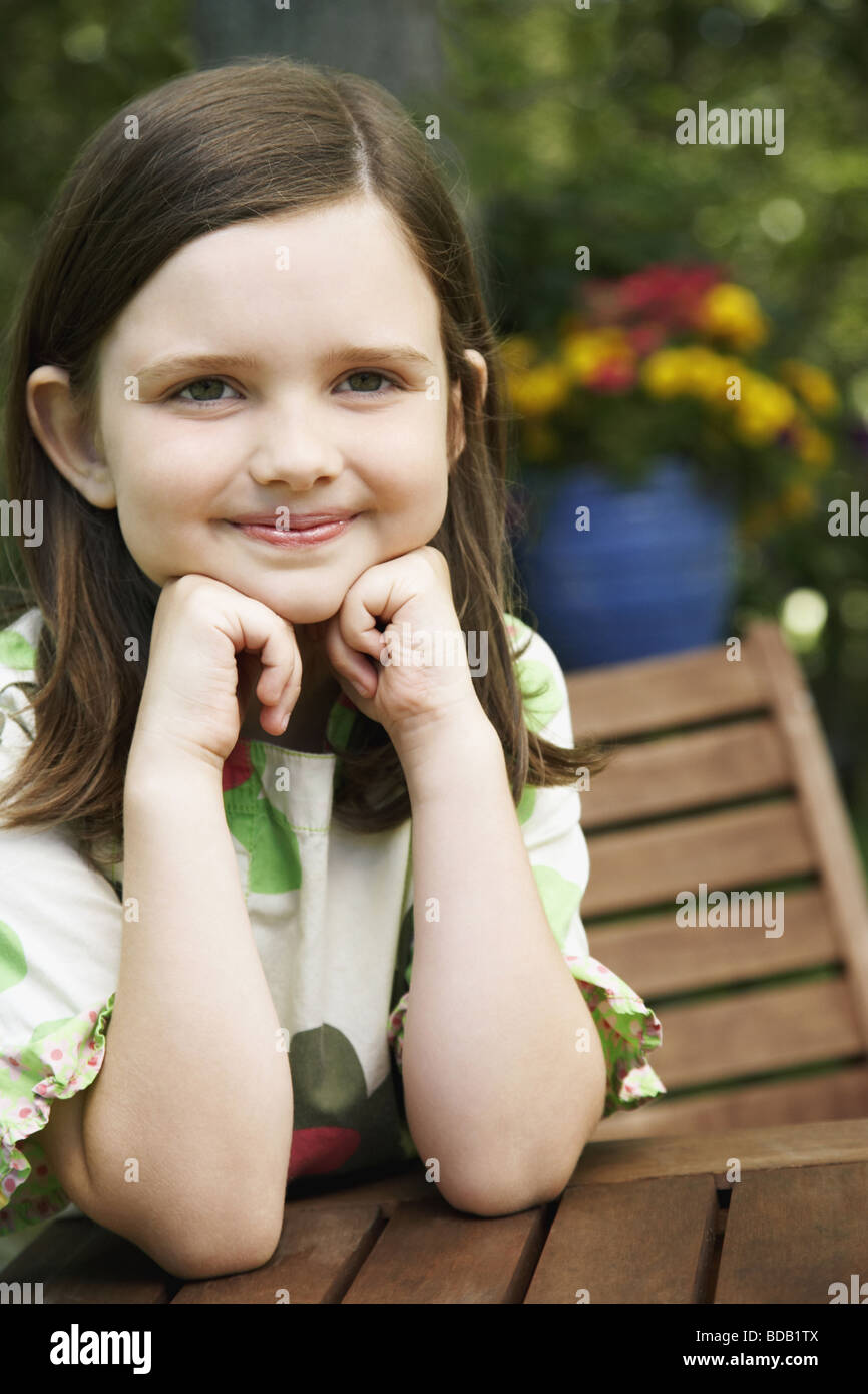 Girl leaning on her elbows and smiling Stock Photo - Alamy
