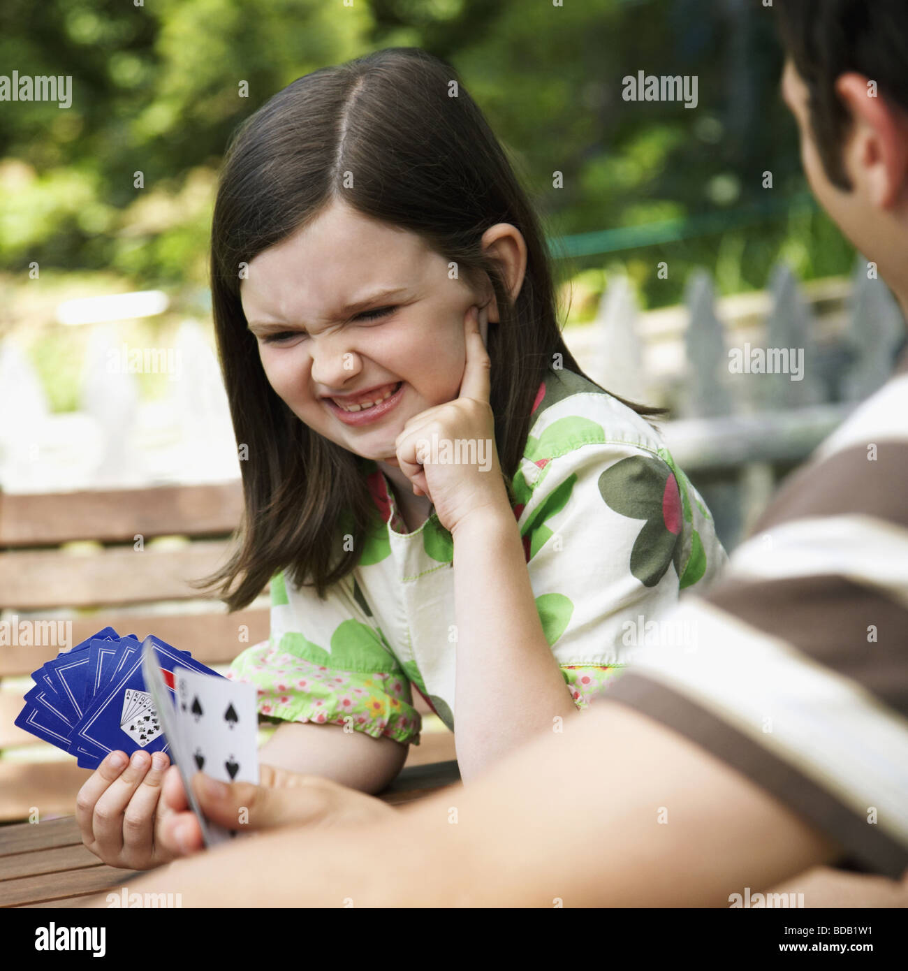 Girl playing cards with a young man Stock Photo - Alamy