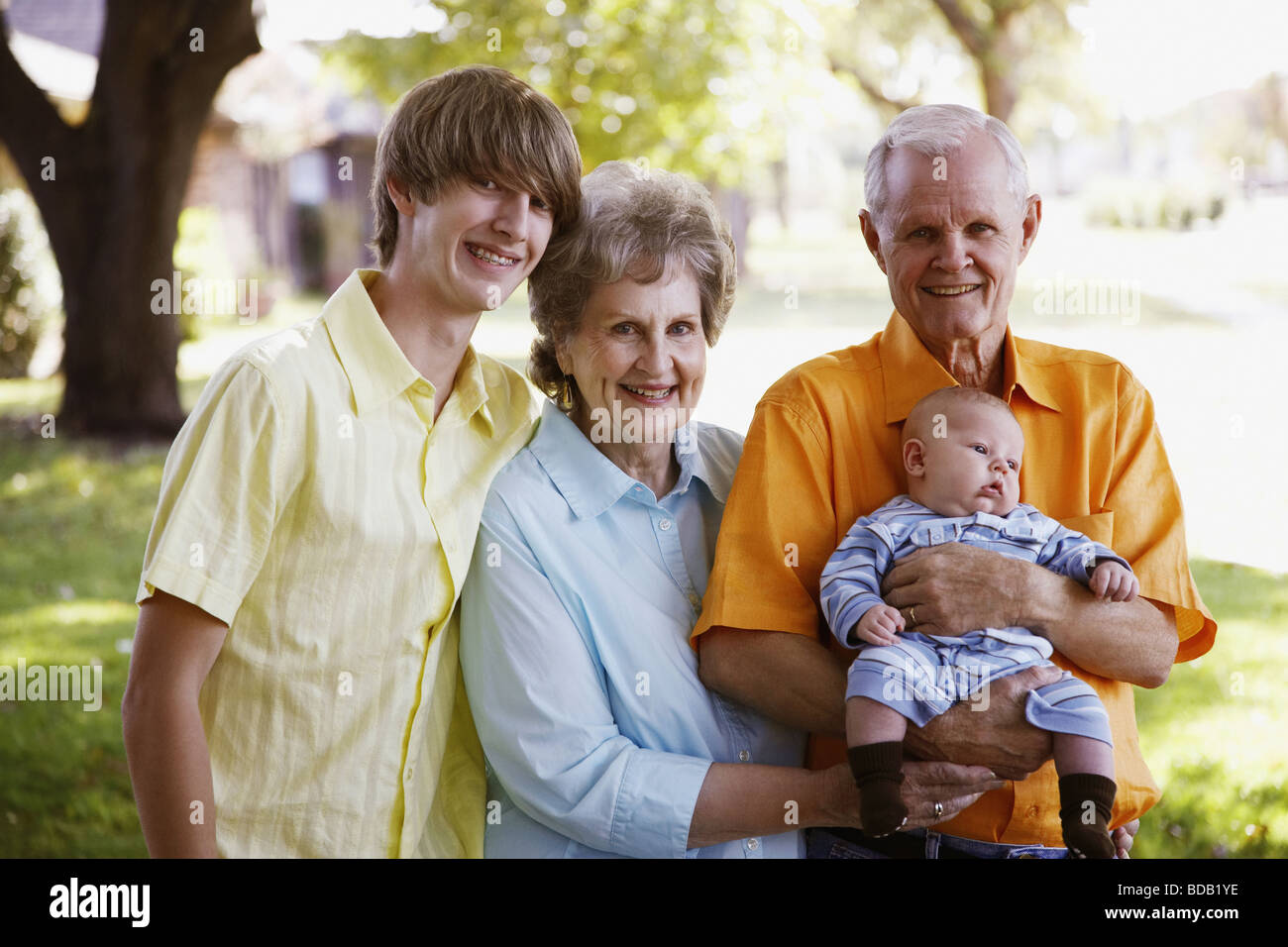 Portrait of a family standing side by side and smiling Stock Photo - Alamy