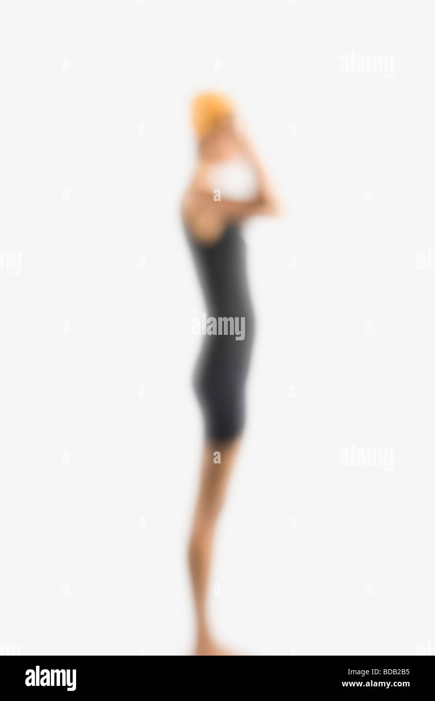 Side profile of a young woman wearing swimwear and standing Stock Photo ...