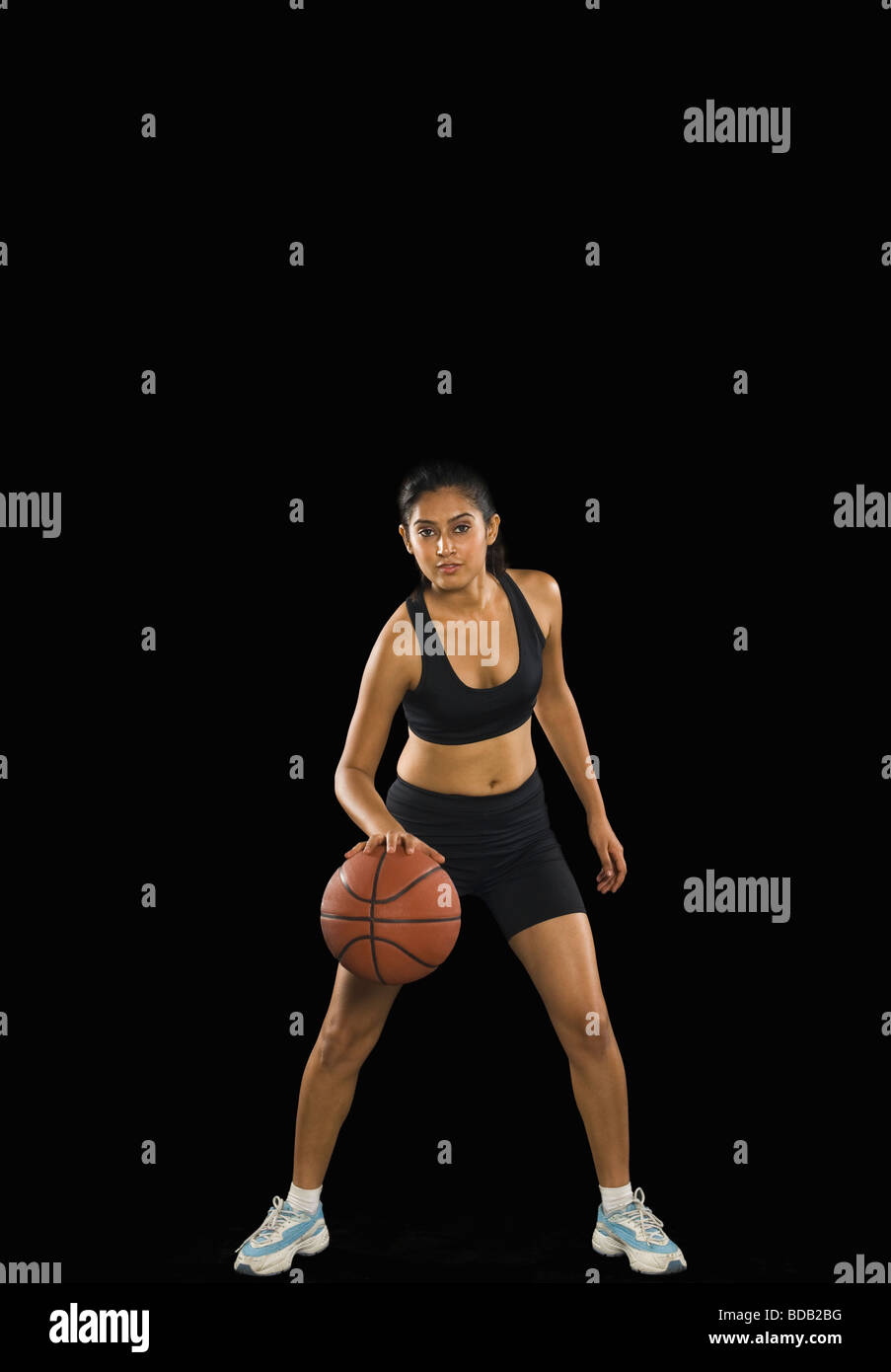 Portrait of a young woman playing basketball Stock Photo - Alamy