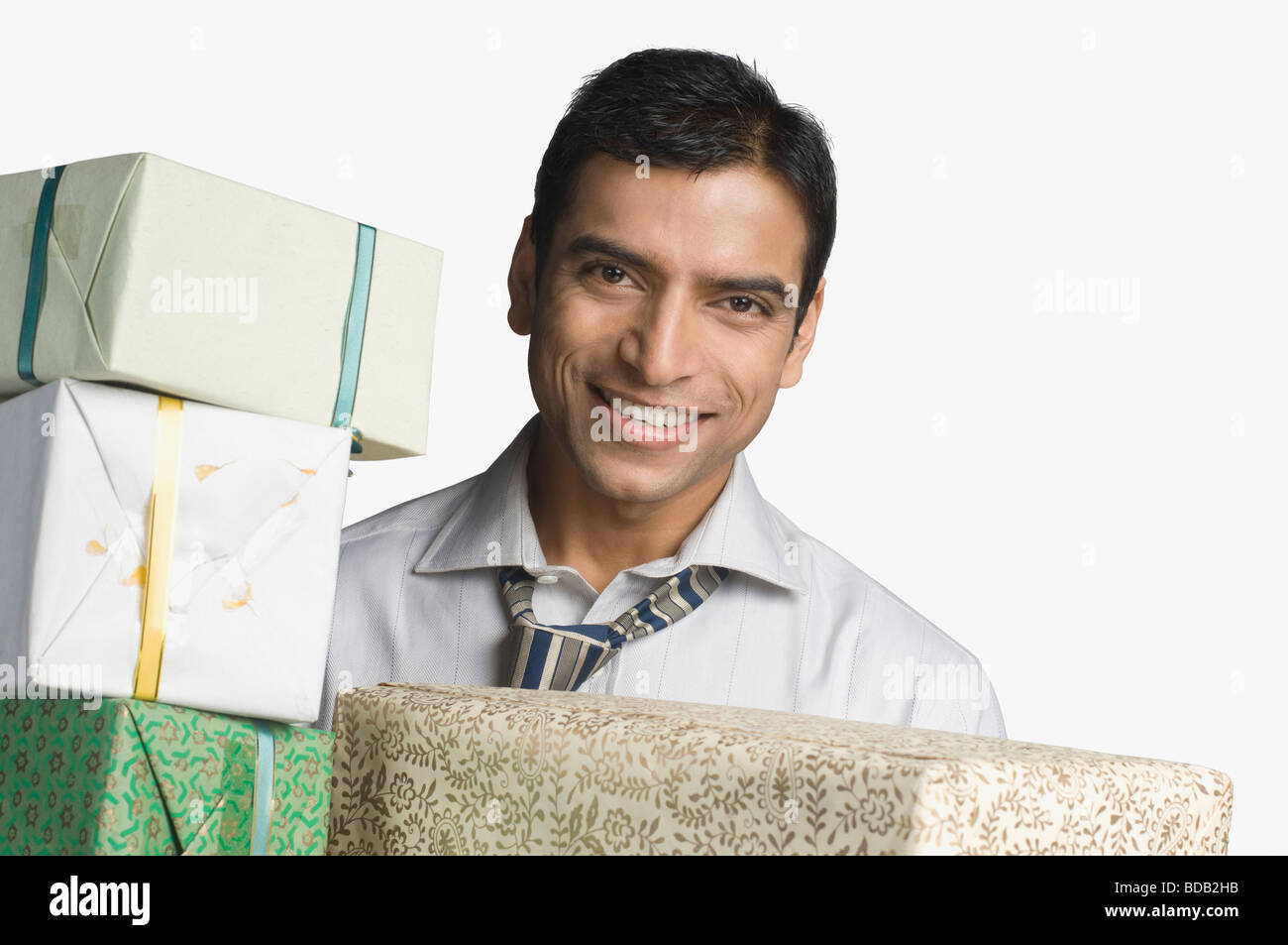 Businessman holding gift boxes Stock Photo - Alamy