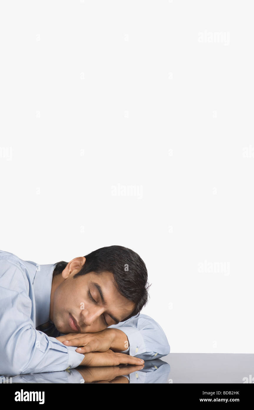 Businessman sleeping on his desk Stock Photo - Alamy