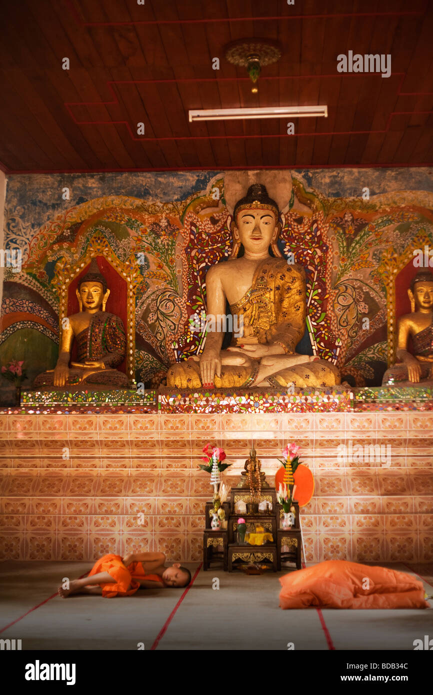 Samanera (small monk) sleeping undder of The Buddha Image,in temple ...