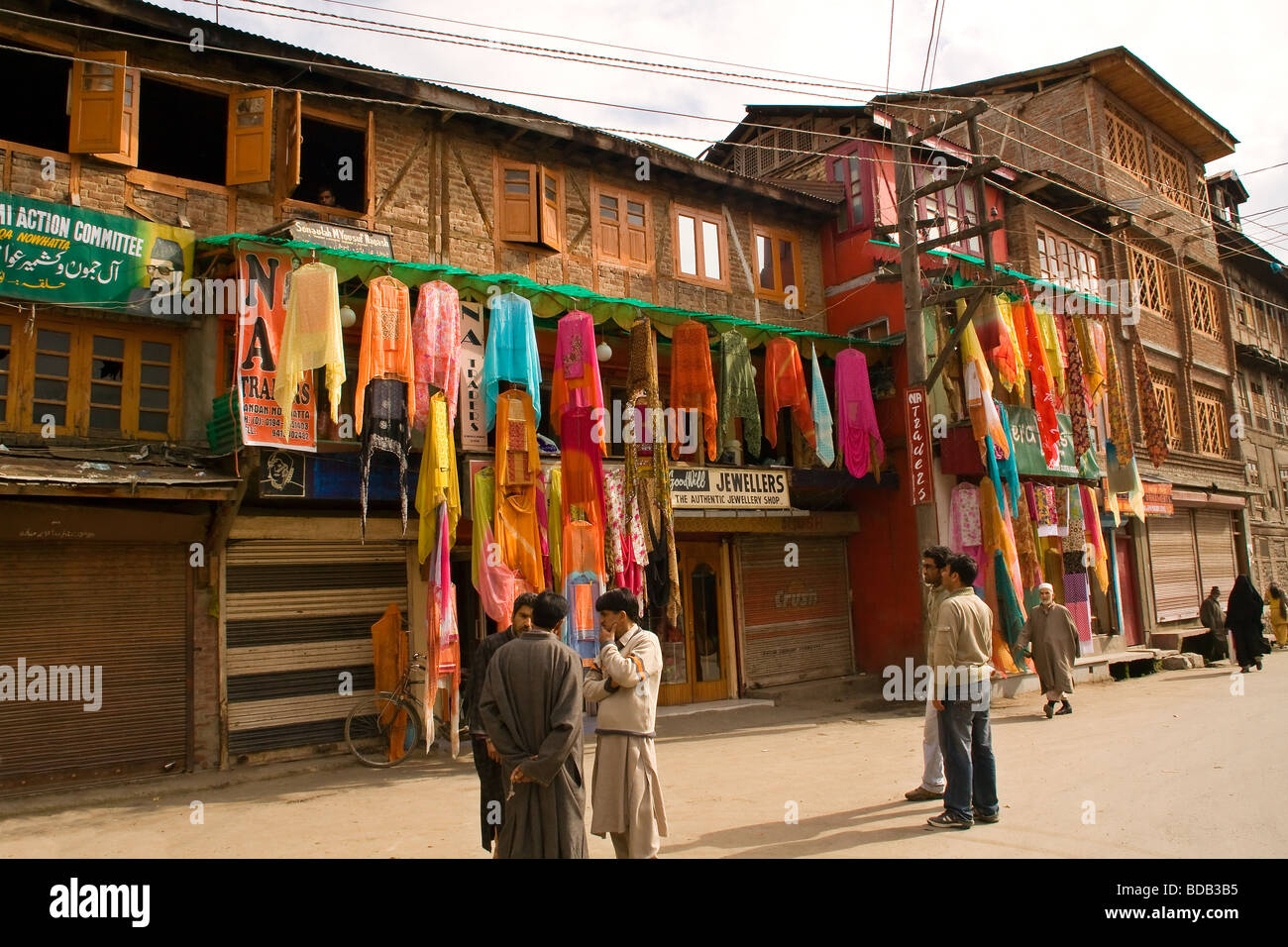 Row of shops in Srinagar Old Town displaying hand made silk saris on ...