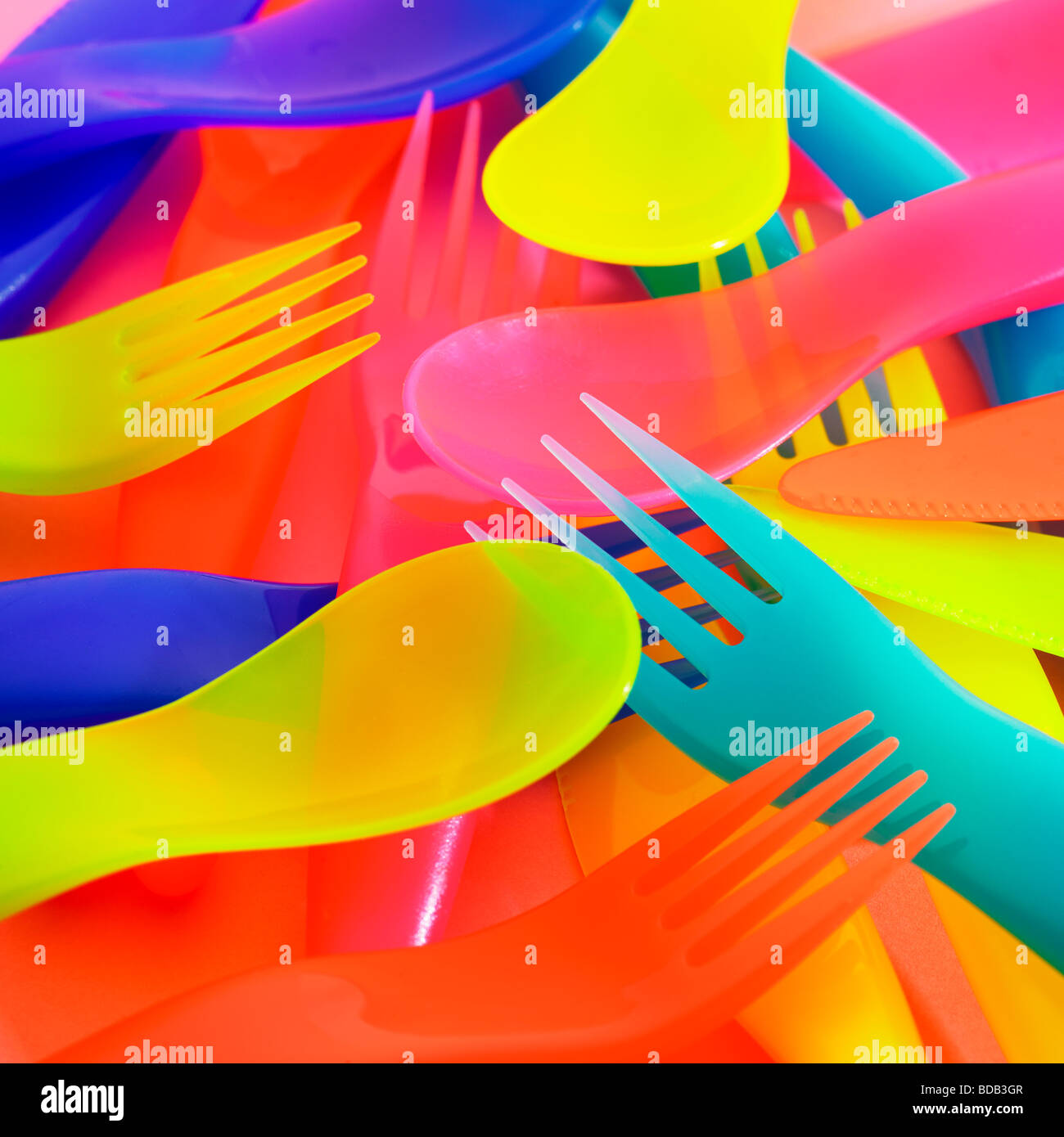 Brightly coloured plastic cutlery Stock Photo - Alamy