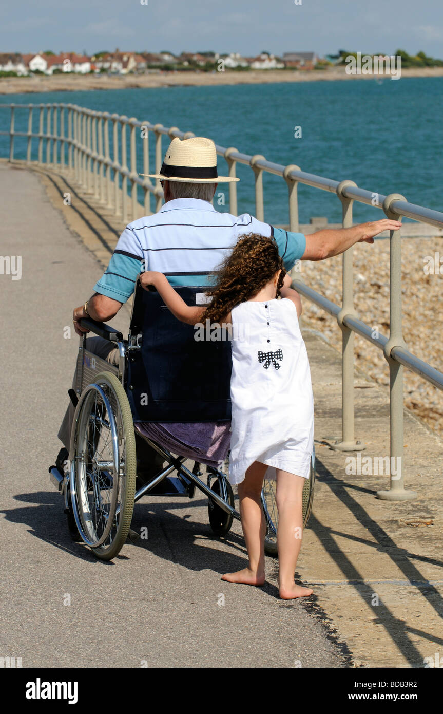 Child Pushing Wheelchair Stock Photos & Child Pushing Wheelchair Stock ...