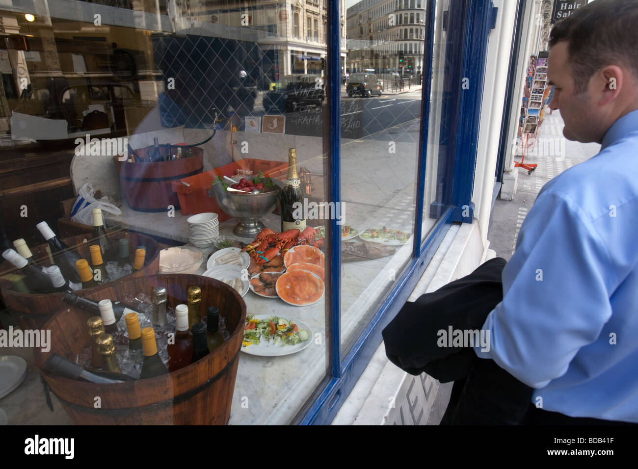 a man looking through the window of Swithins Seafood Restaurant in the ...