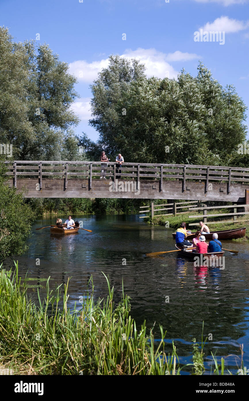 people watching from a bridge with rowing boats passing under, on the ...