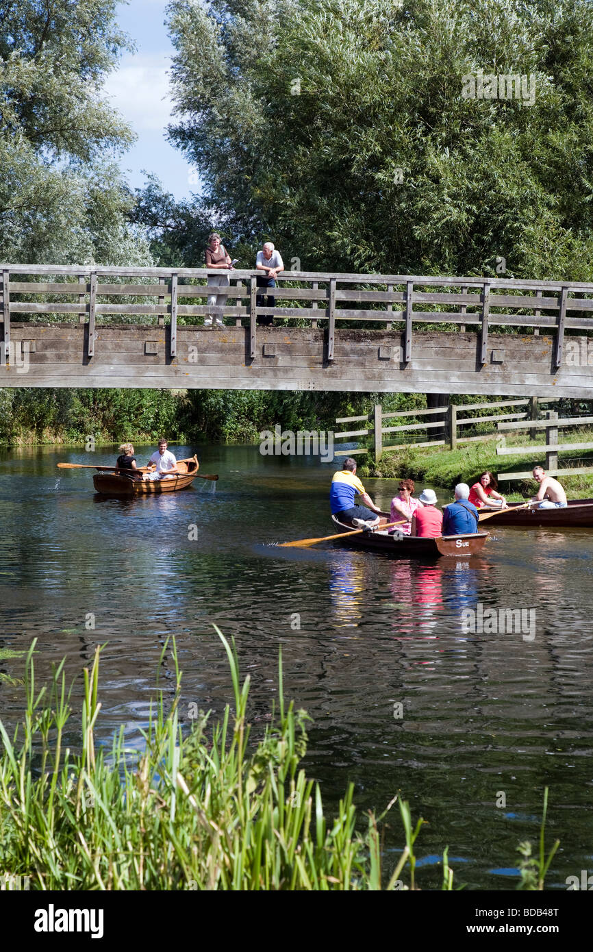 people watching from a bridge with rowing boats passing under, on the ...