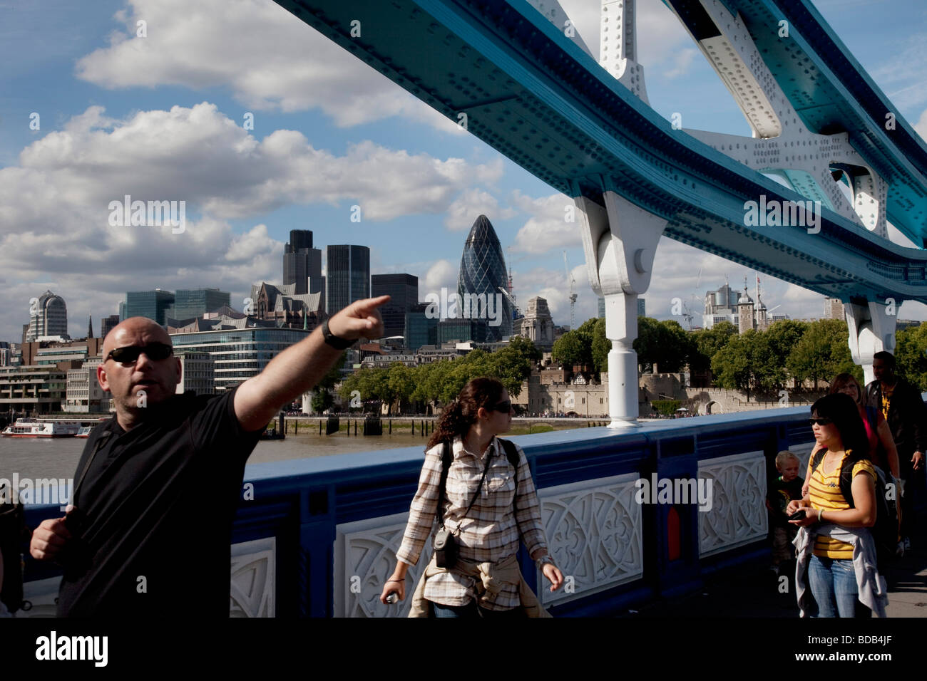 Tourists cross Tower Bridge. The newly repainted bridge is a big draw ...