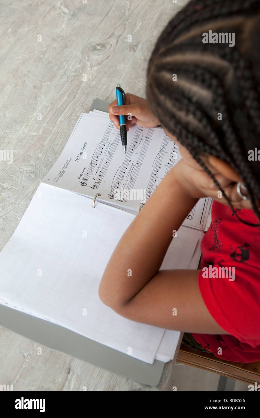 Little girl is making her music homework Stock Photo - Alamy