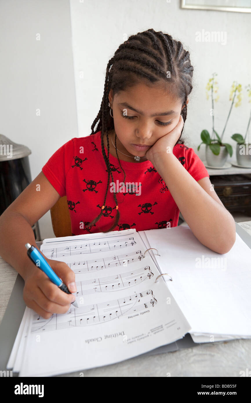 Little girl is making her music homework Stock Photo - Alamy