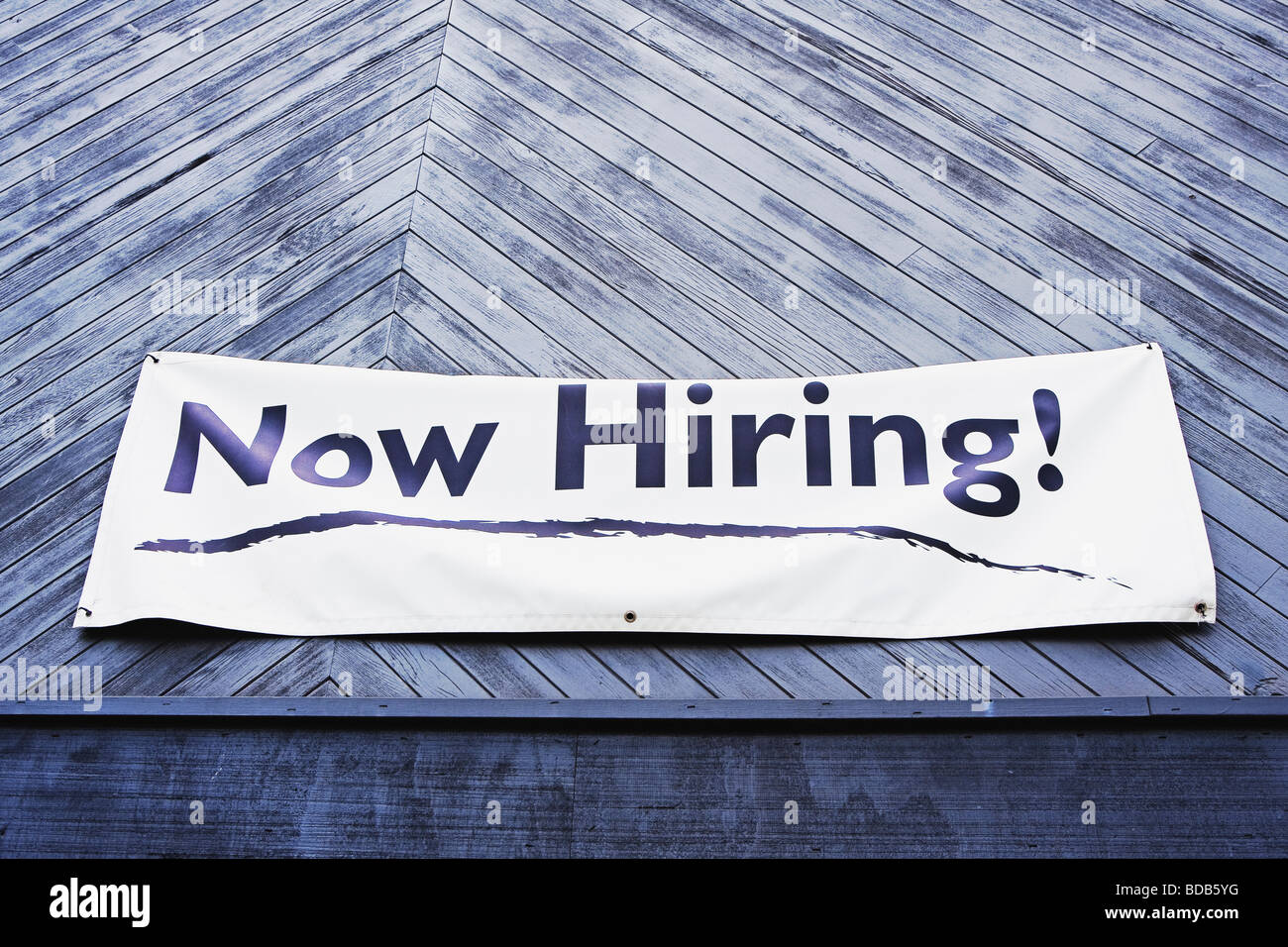 now hiring sign hanging on facade of strip club Stock Photo - Alamy