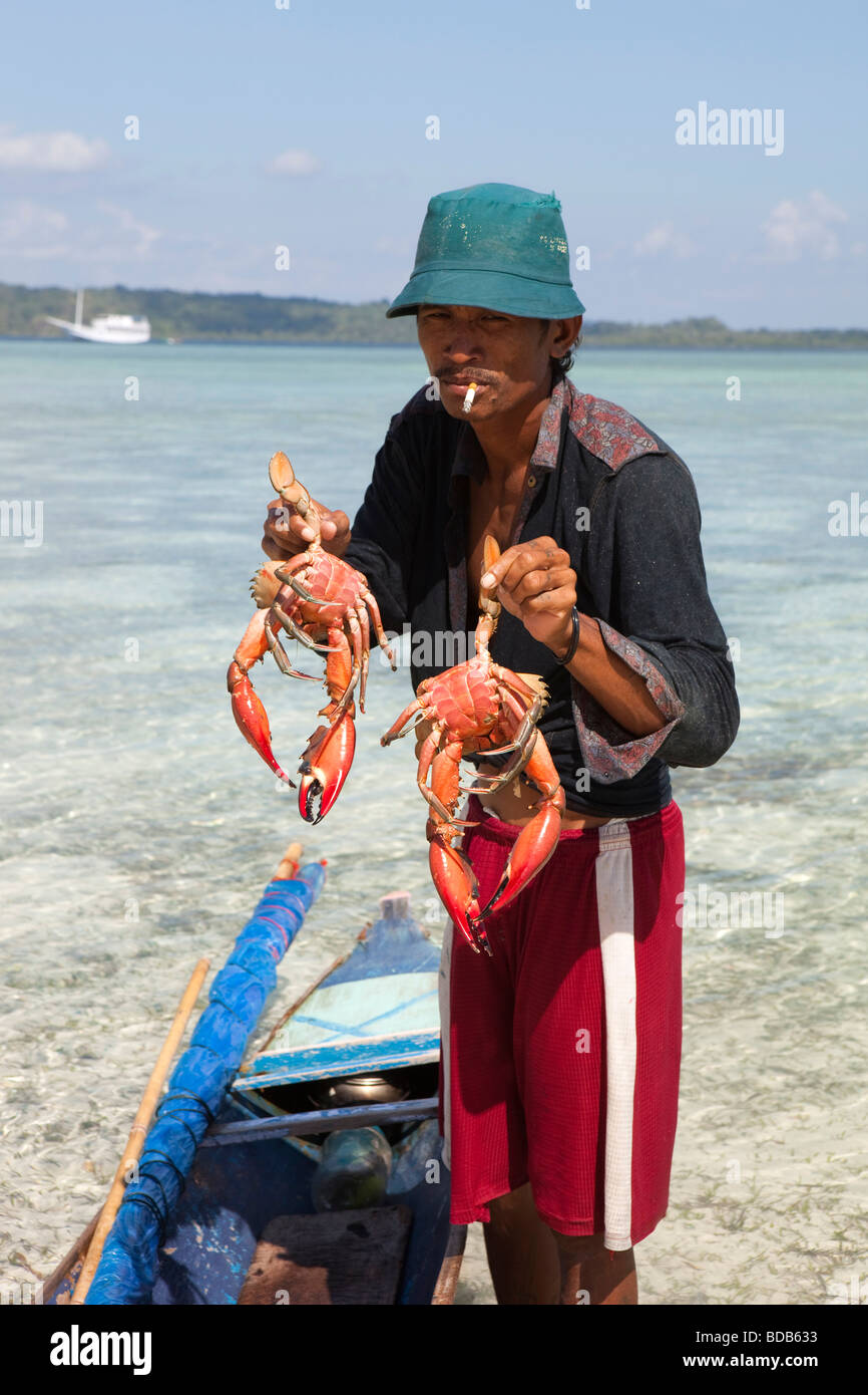 Indonesia Sulawesi Wakatobi National Park Hoga Island fisherman holding ...