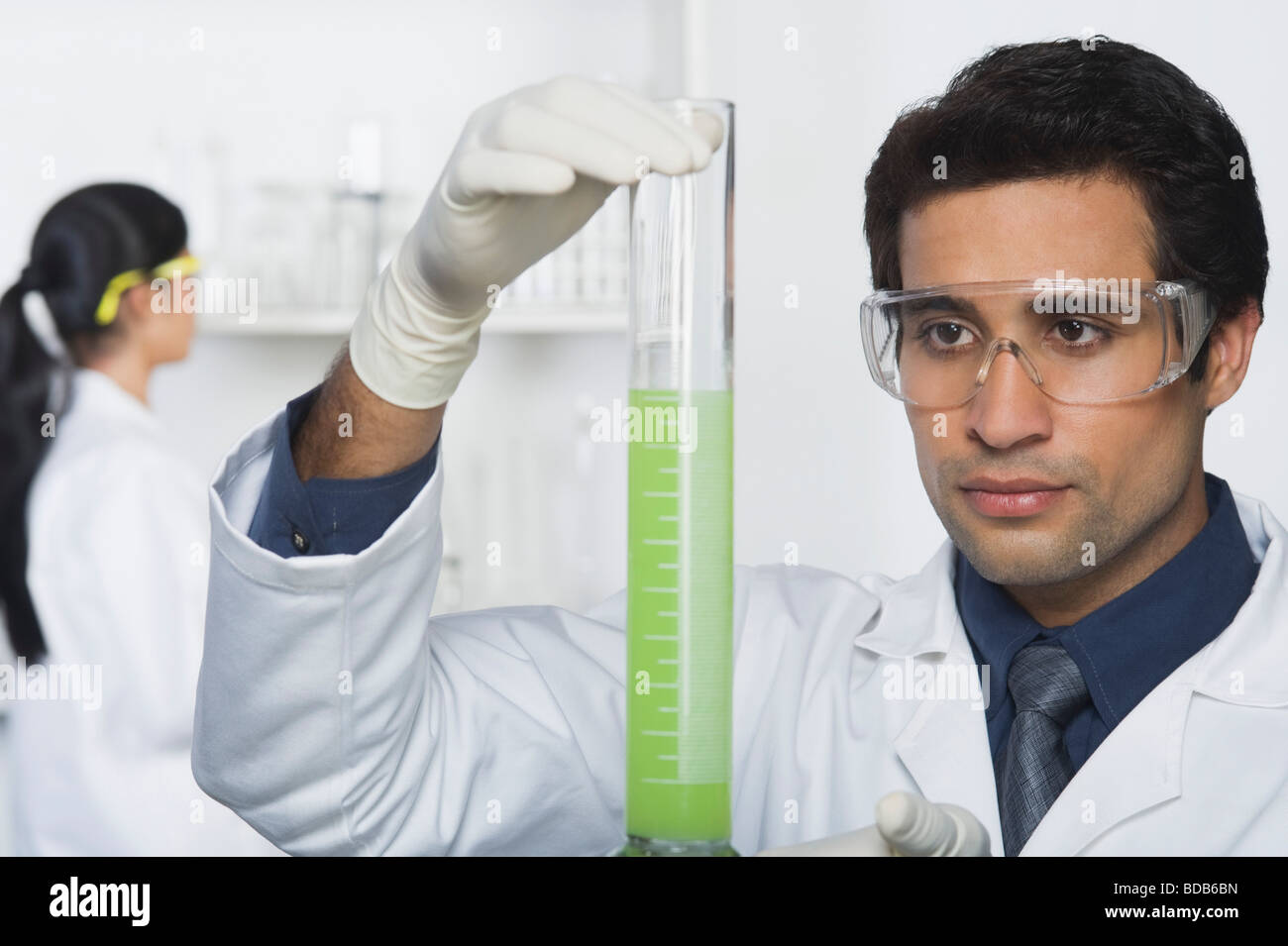 Scientist holding a burette Stock Photo - Alamy