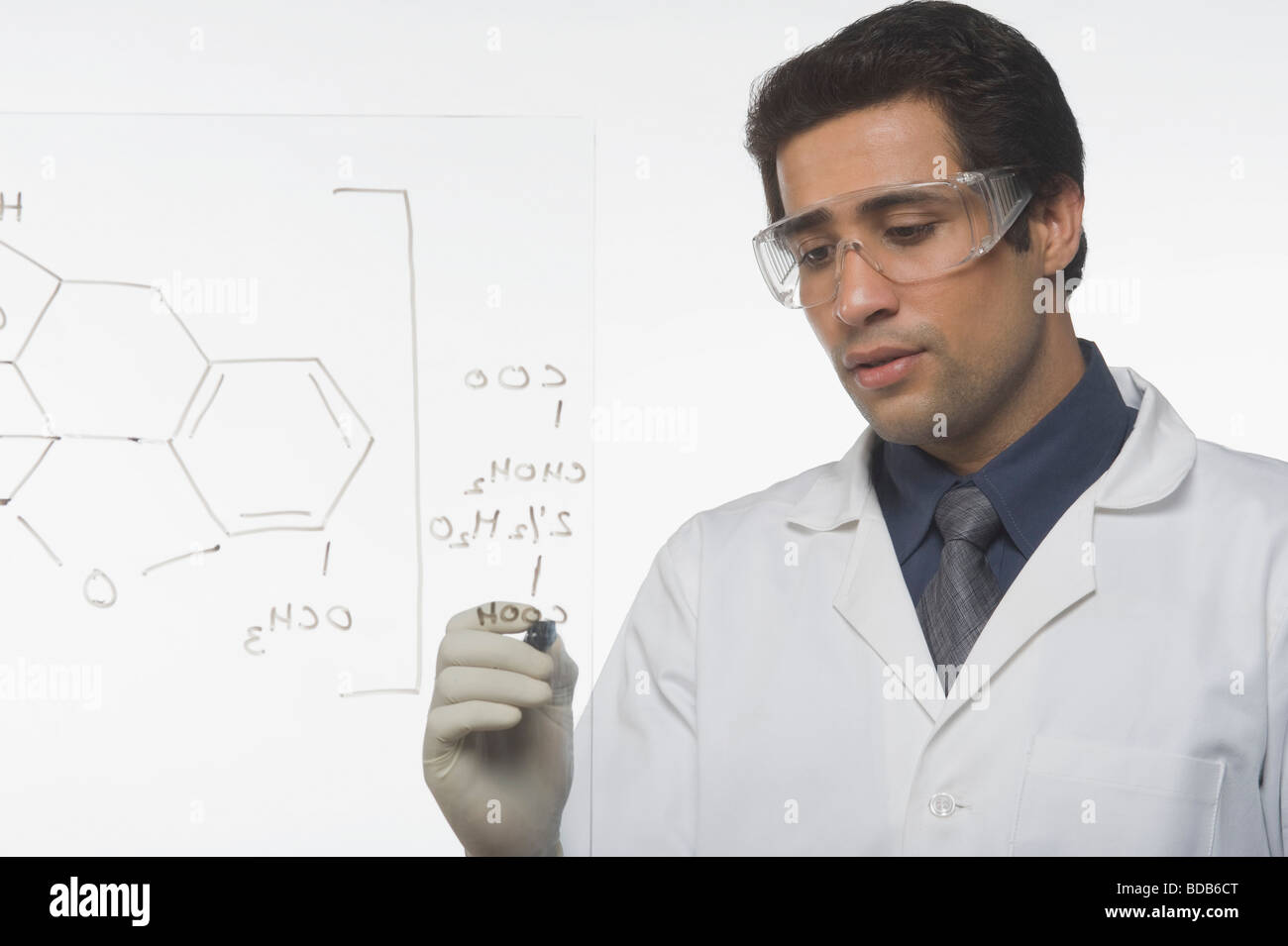 Scientist writing chemical formula Stock Photo - Alamy