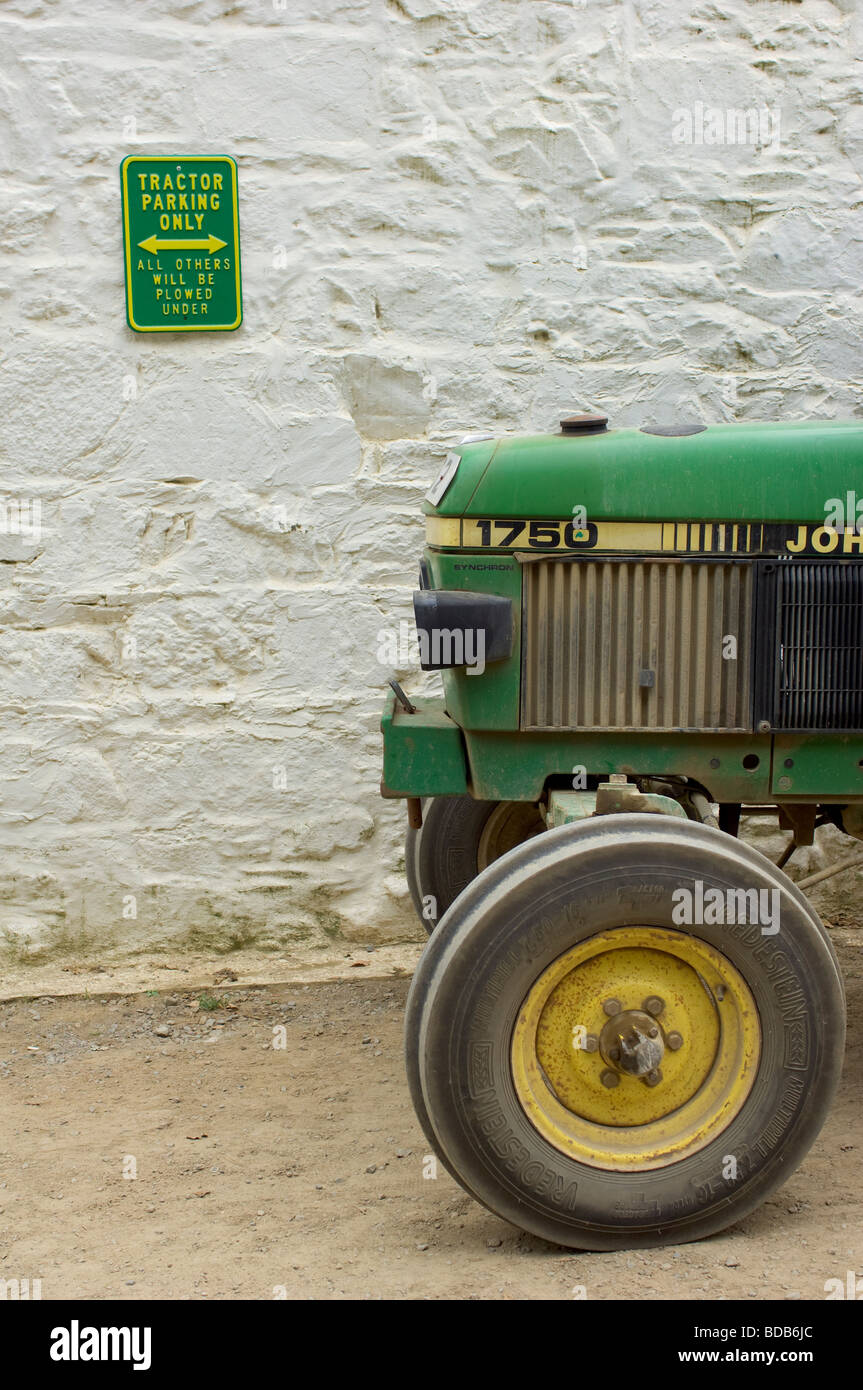 Green tractor parked outside of the Bel Air Inn, next to 'Tractor ...