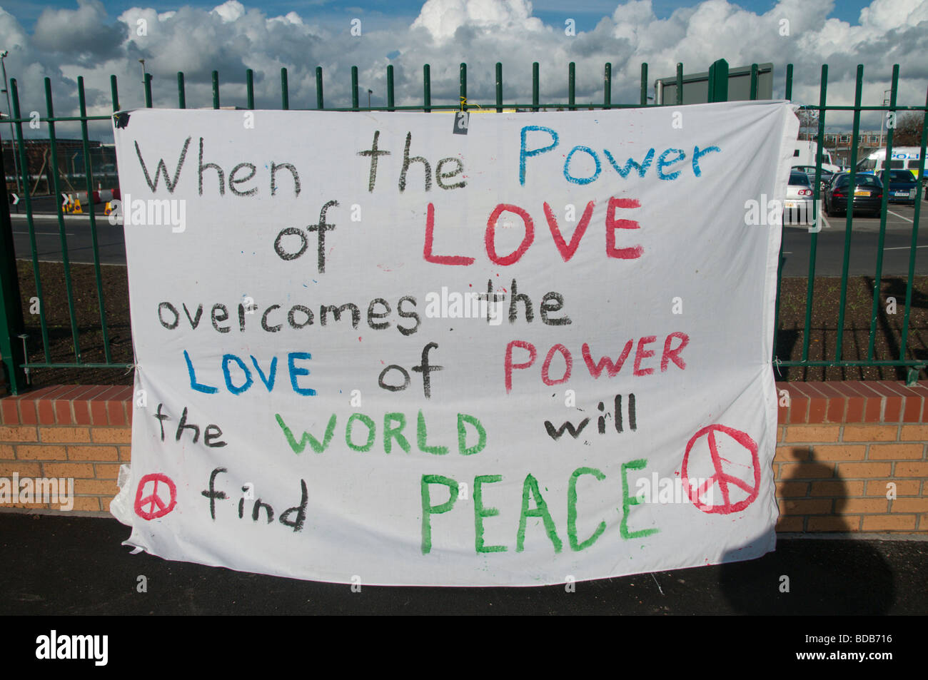 Banner on fence at Aldermaston AWE: "When the power of Love overcomes ...