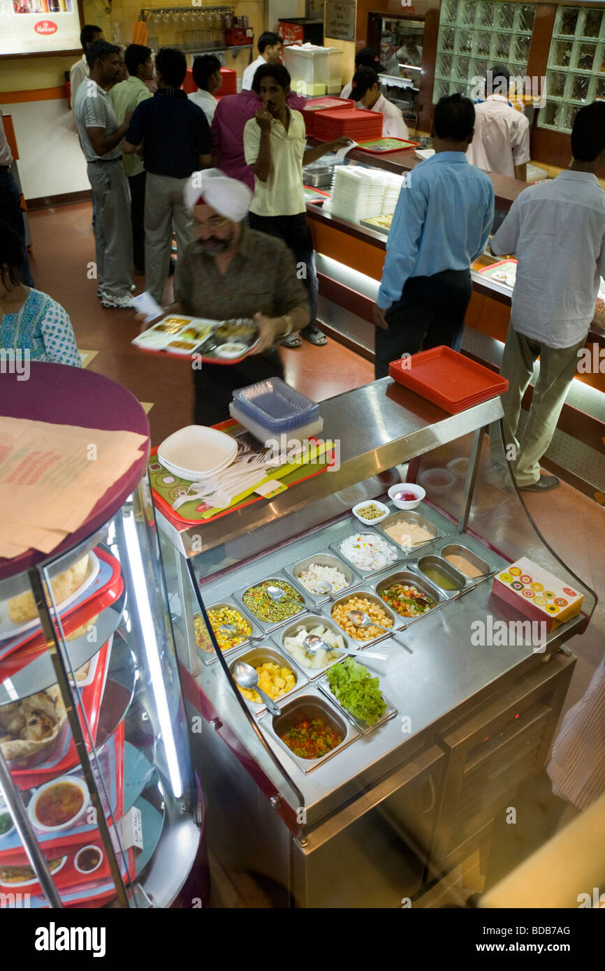 Salad counter at an Indian restaurant & customers queue for fast food ...