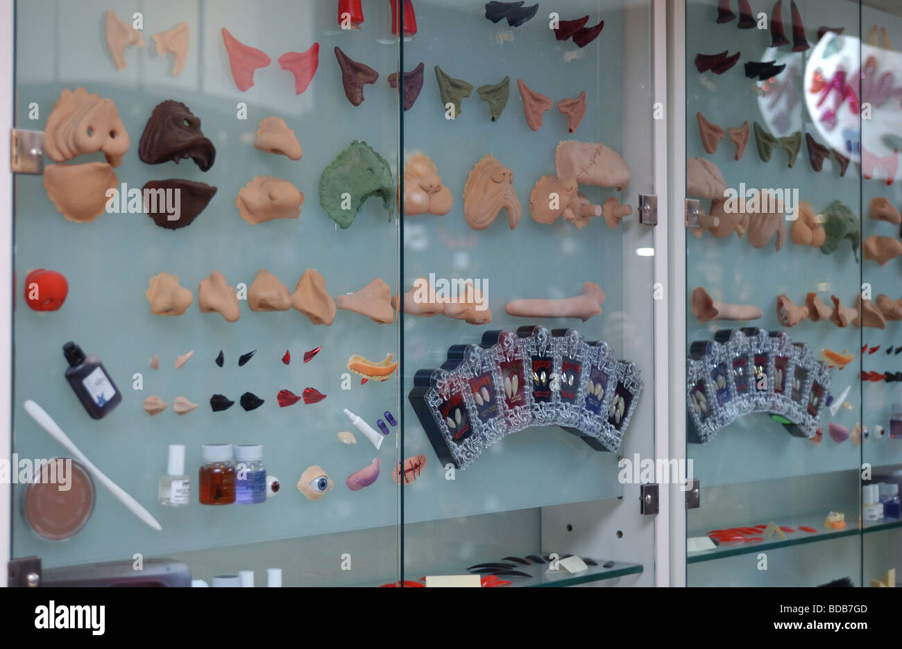 A display of theatrical prosthetic facial features including noses ...